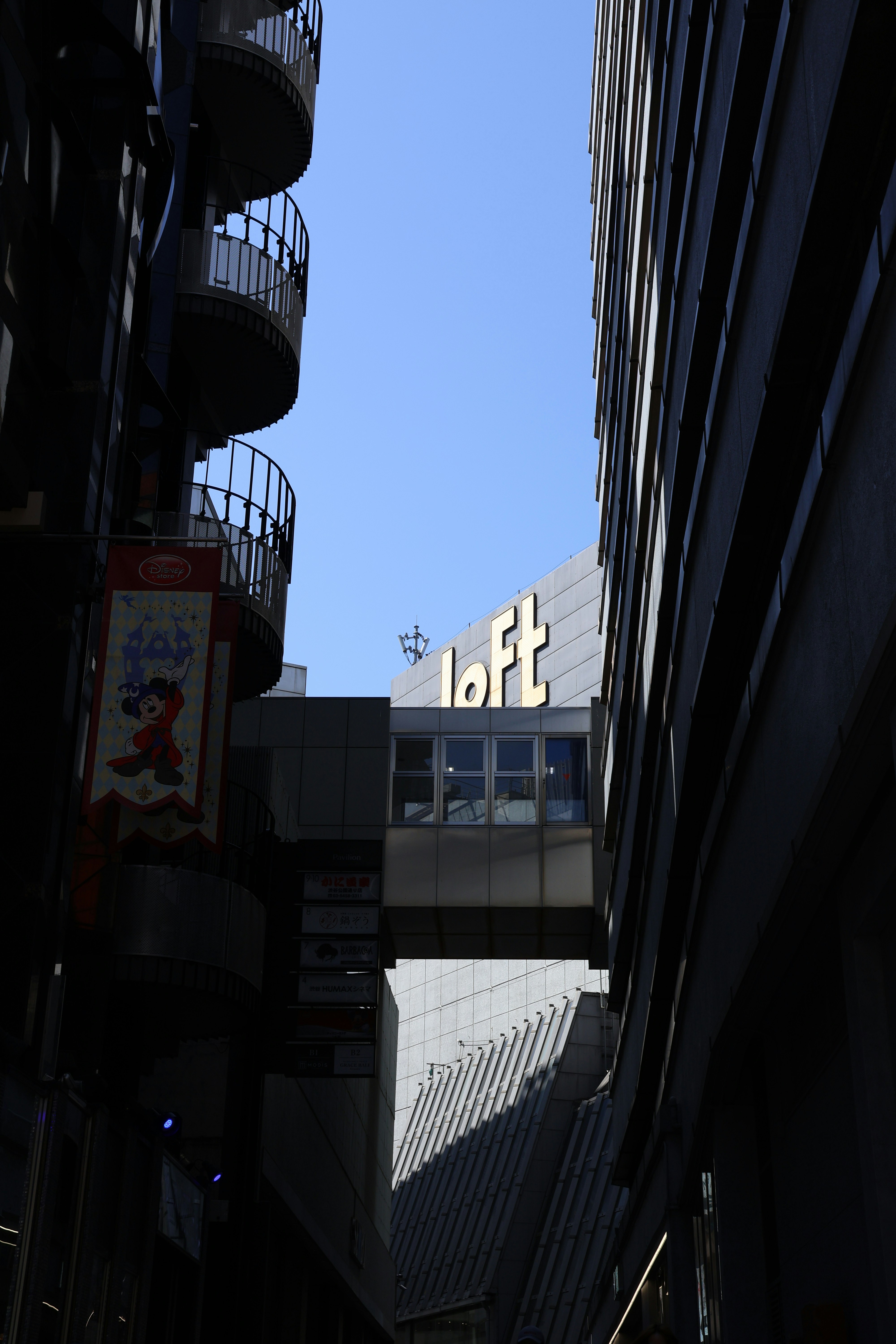 Loft Between Towers: Sky Framing a Narrow City Alley