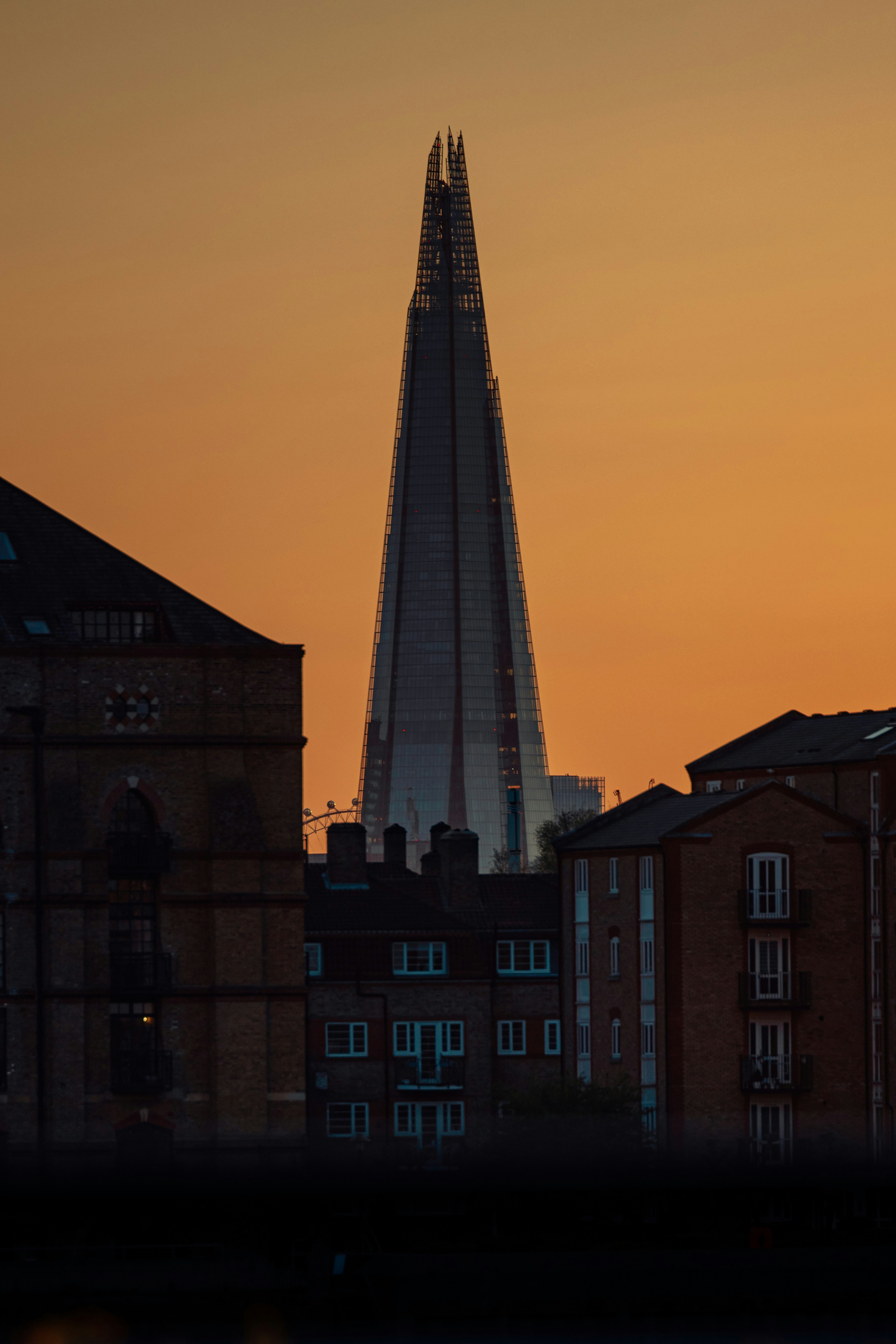 The shard stands tall at sunset in london. photo – Free Canary wharf ...