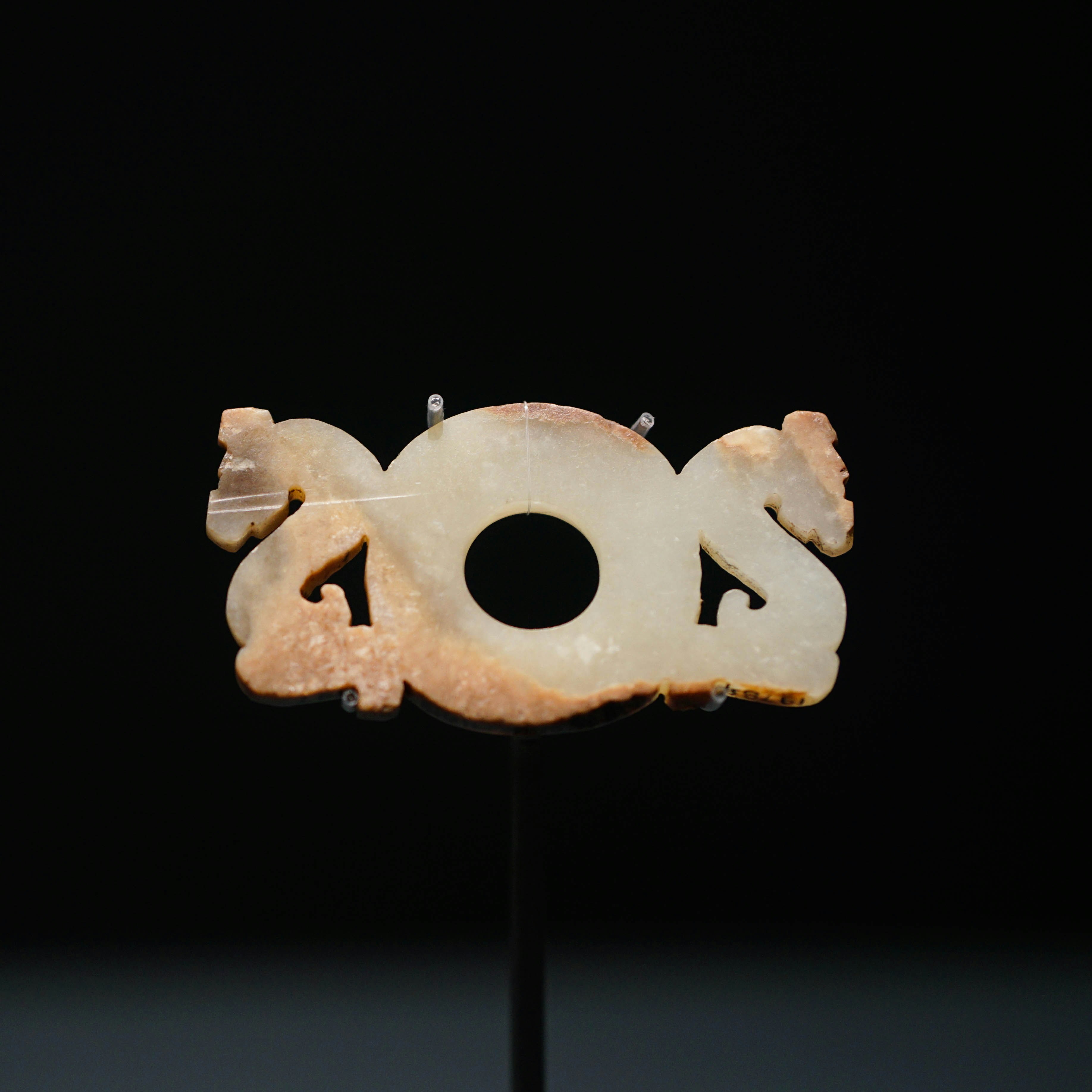 New Year in Bite-Sized Form: A Pale 2020 Cookie on a Stem Against a Black Stage