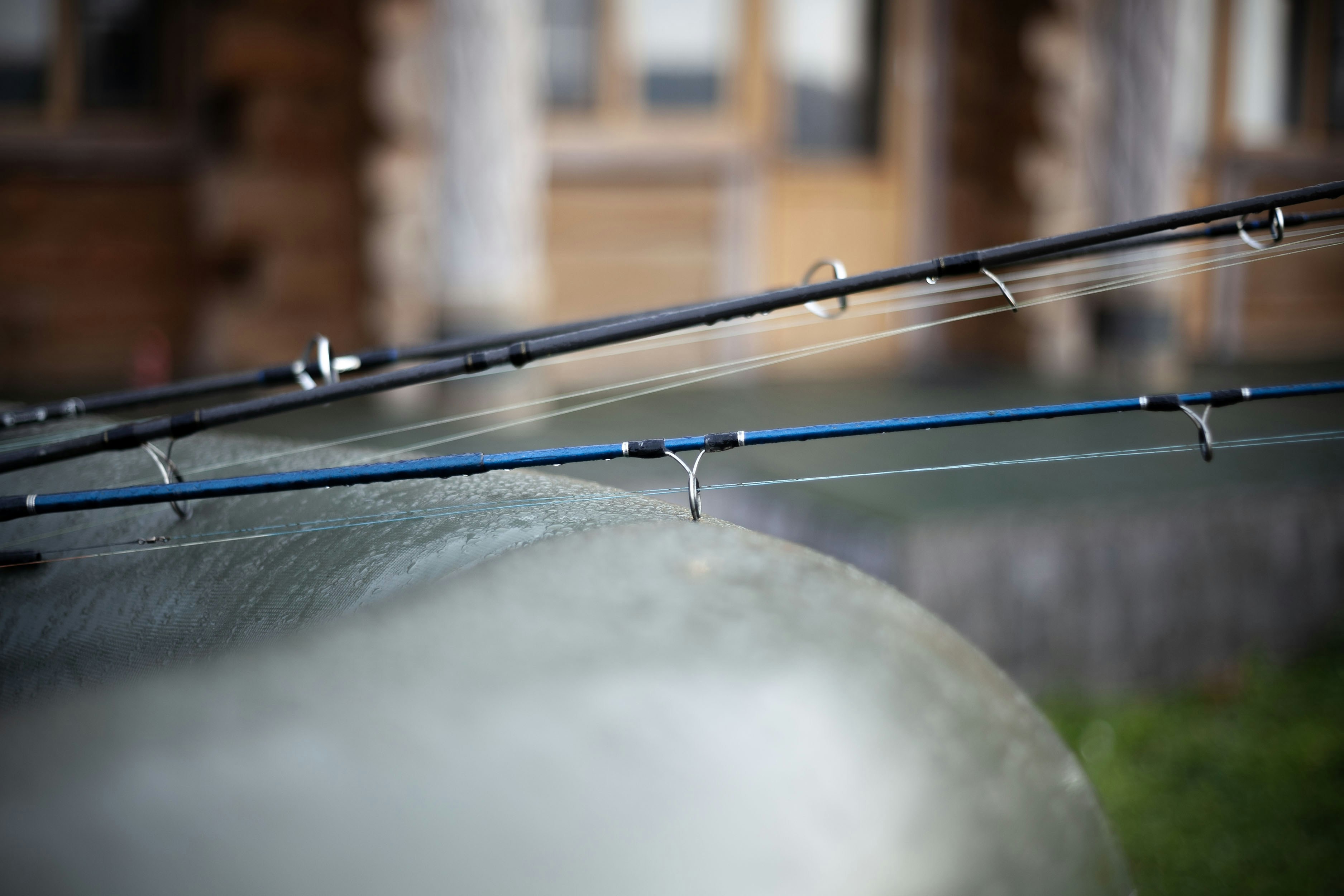 Lines Across Water: Fishing Rods Resting on a Weathered Boat