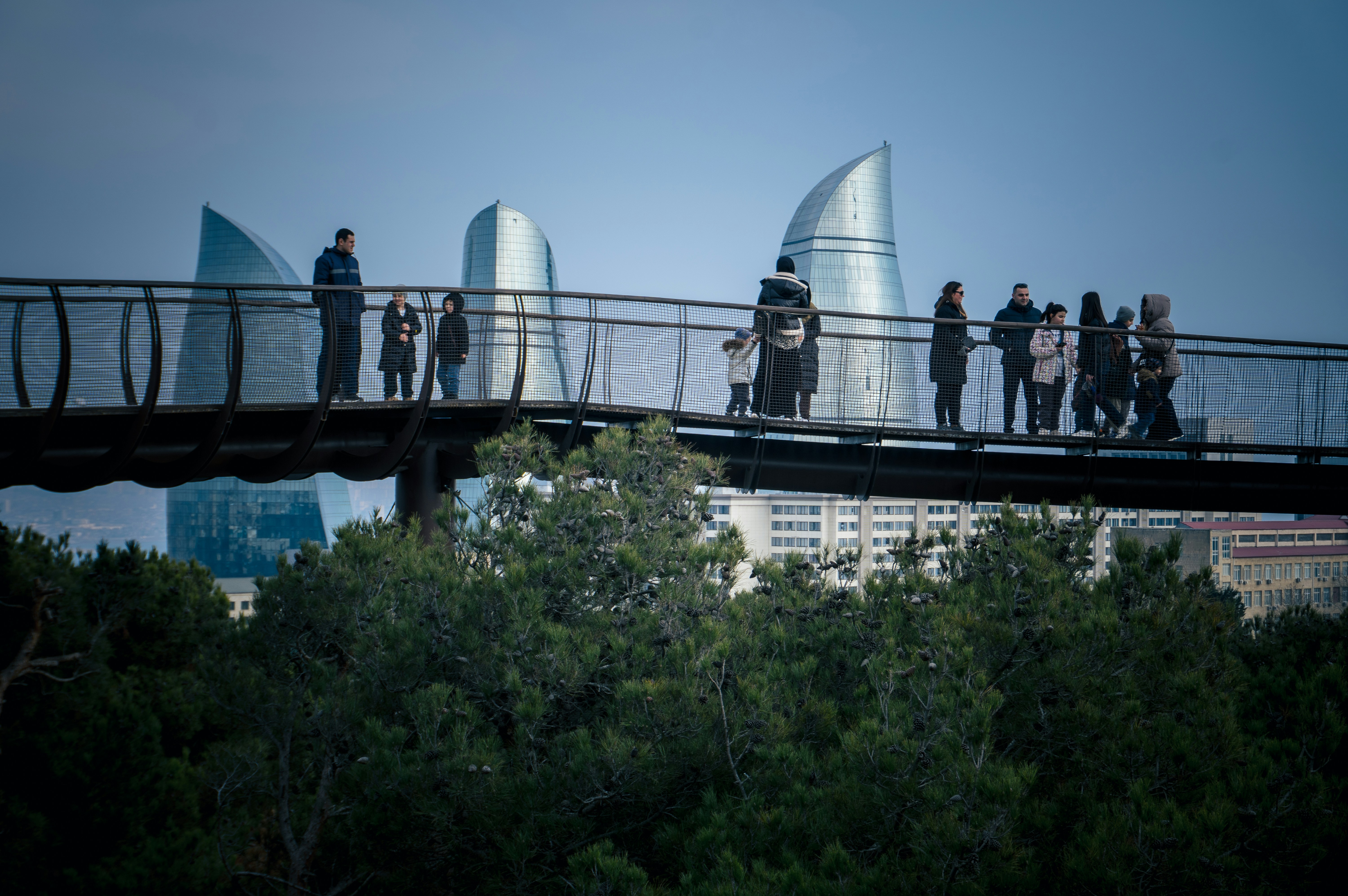 People are walking on a bridge by futuristic buildings. photo – Free ...
