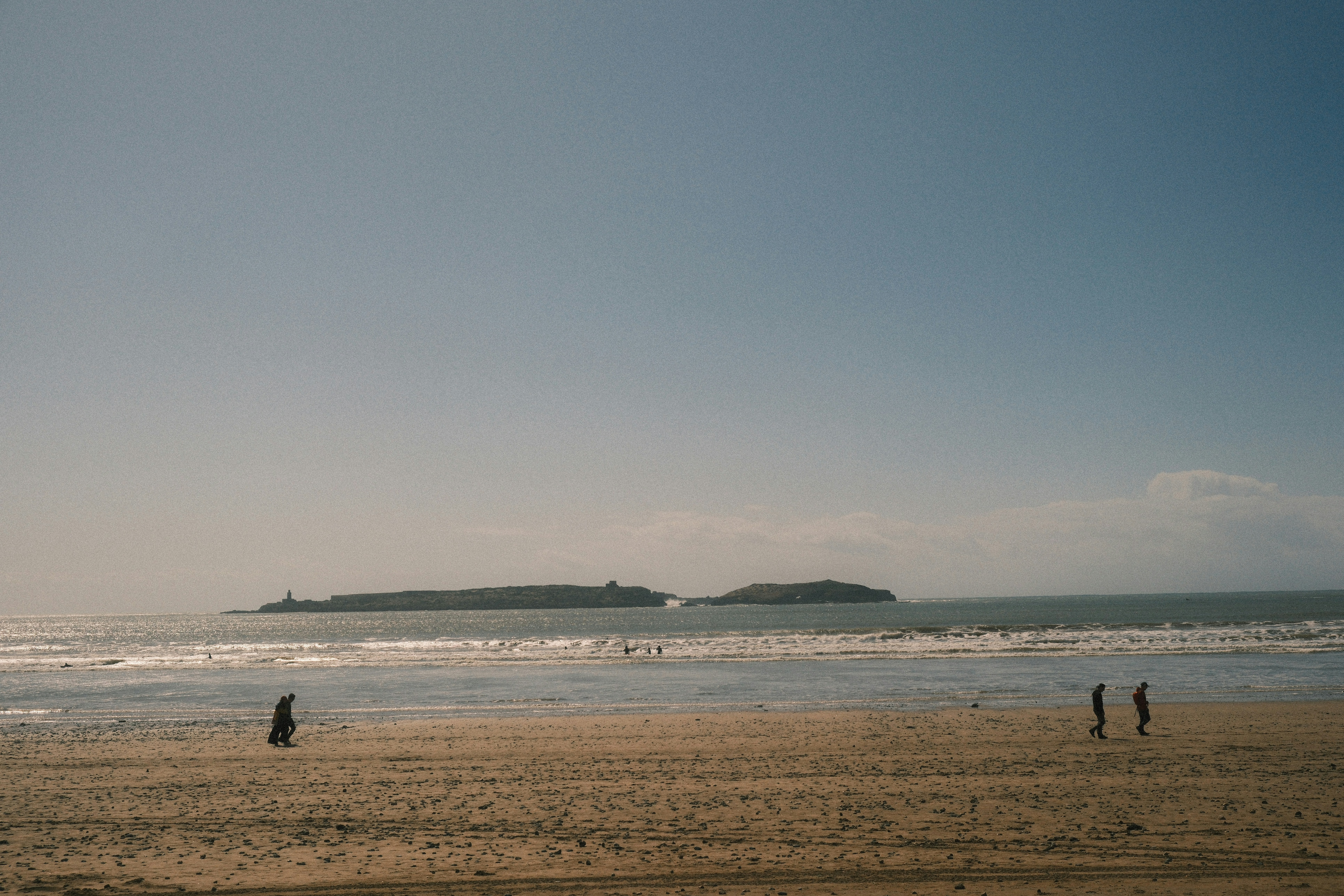 Distant Islet Framing a Calm Beach: A Minimal Seascape at Noon