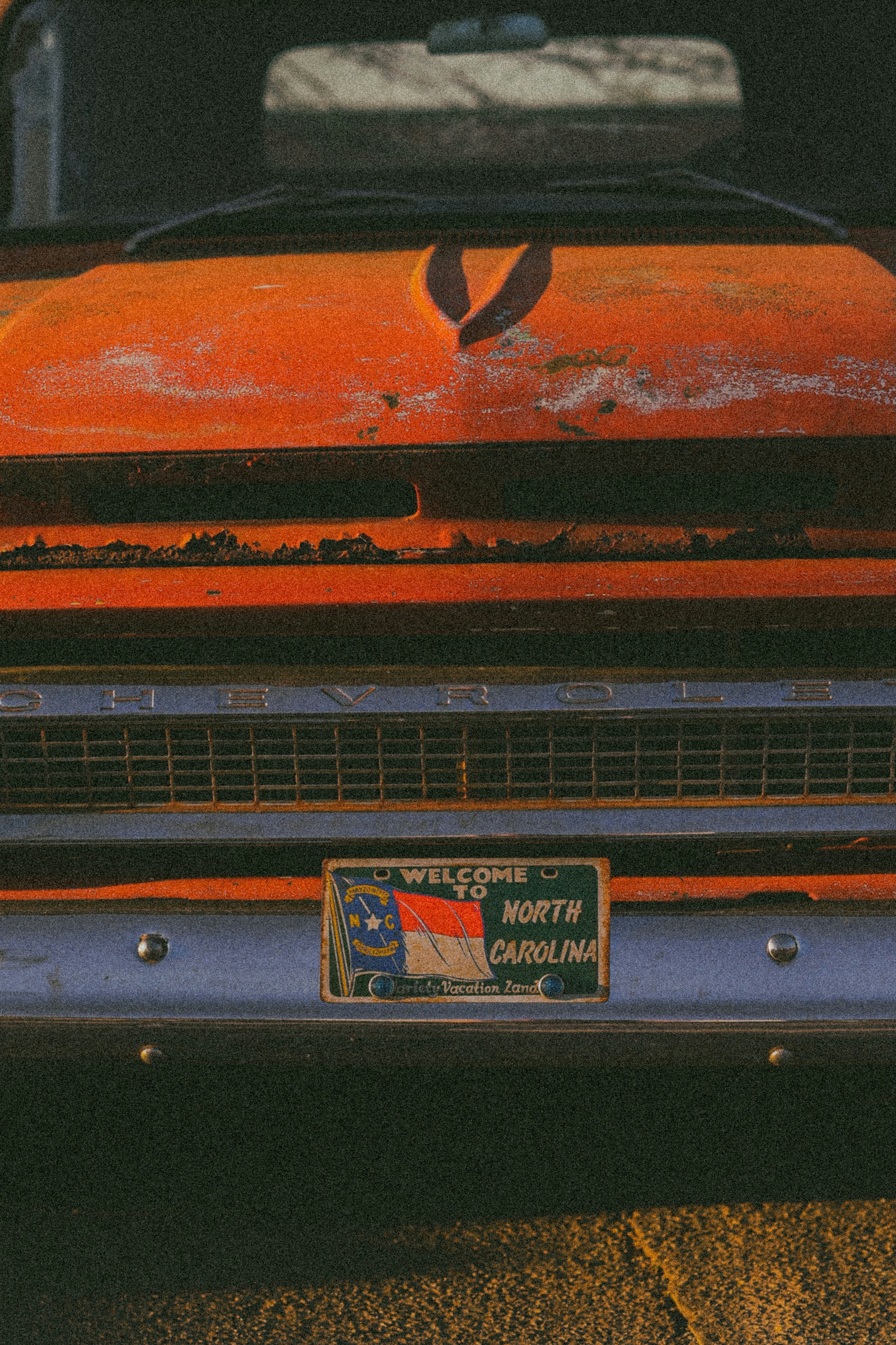 Rusted Orange Sentinel: A Vintage Chevy Guarding the North Carolina Welcome