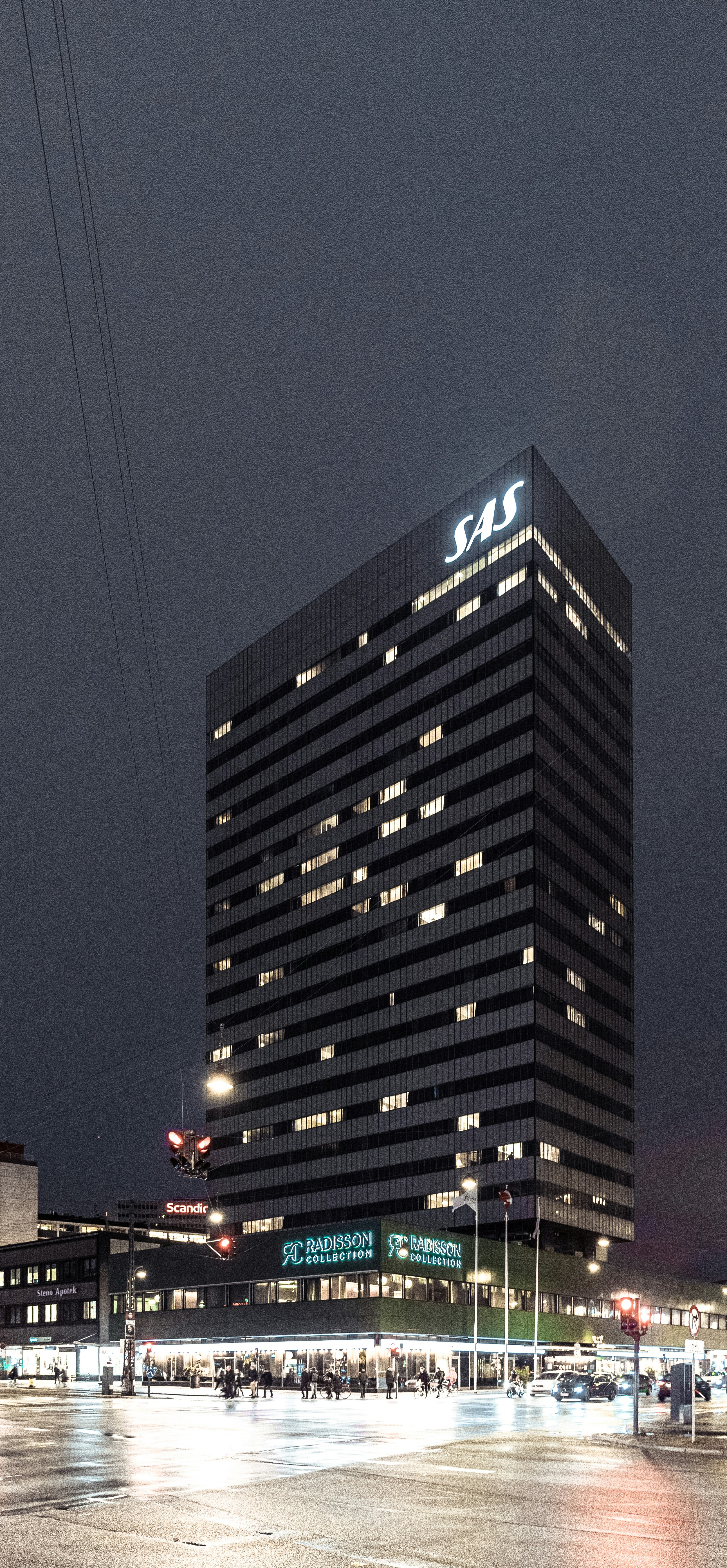 A tall building with the sas logo at night. photo – Free Architecture ...