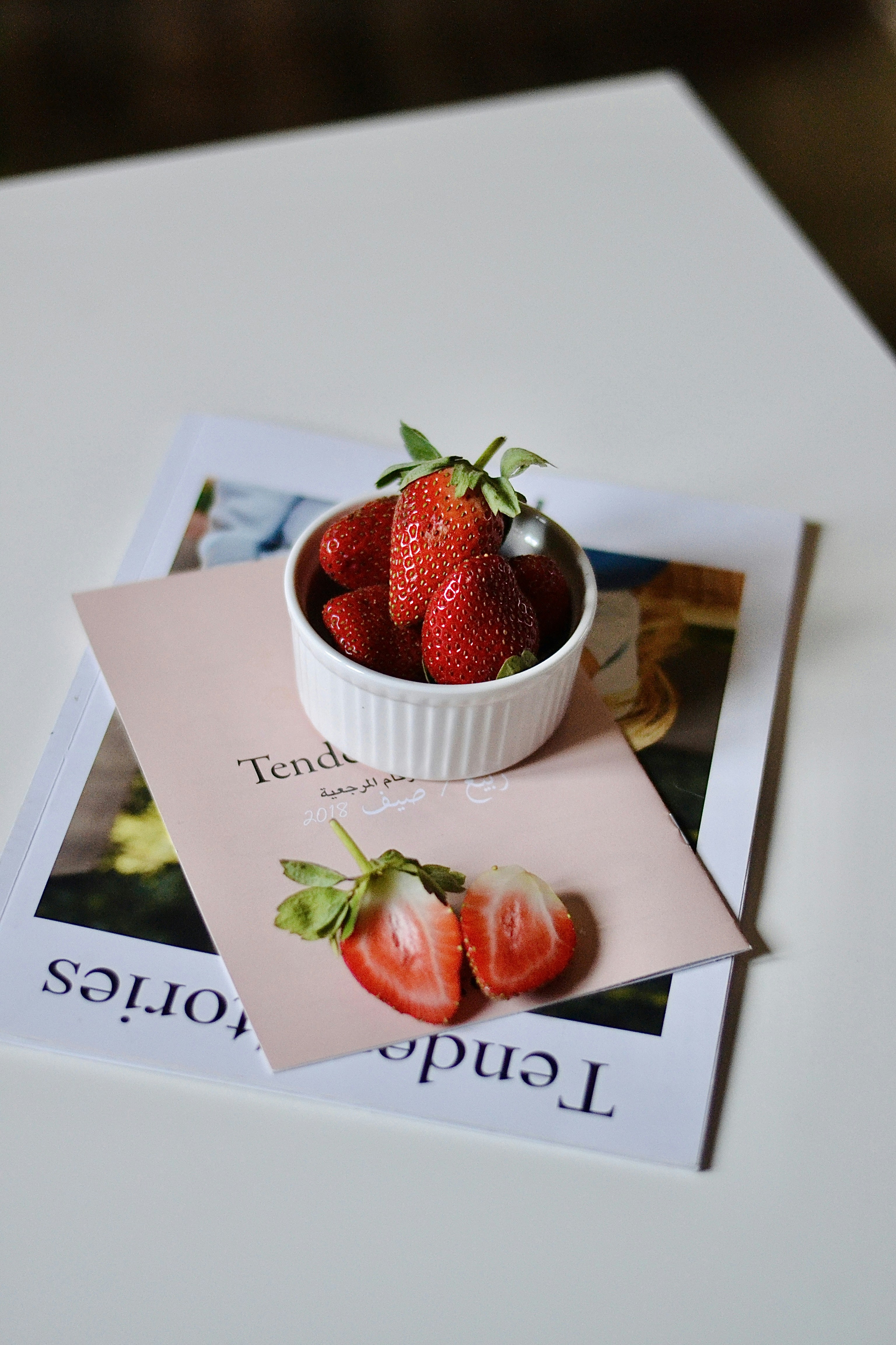 Strawberries in a Tiny White Bowl on a Layered Paper Still Life