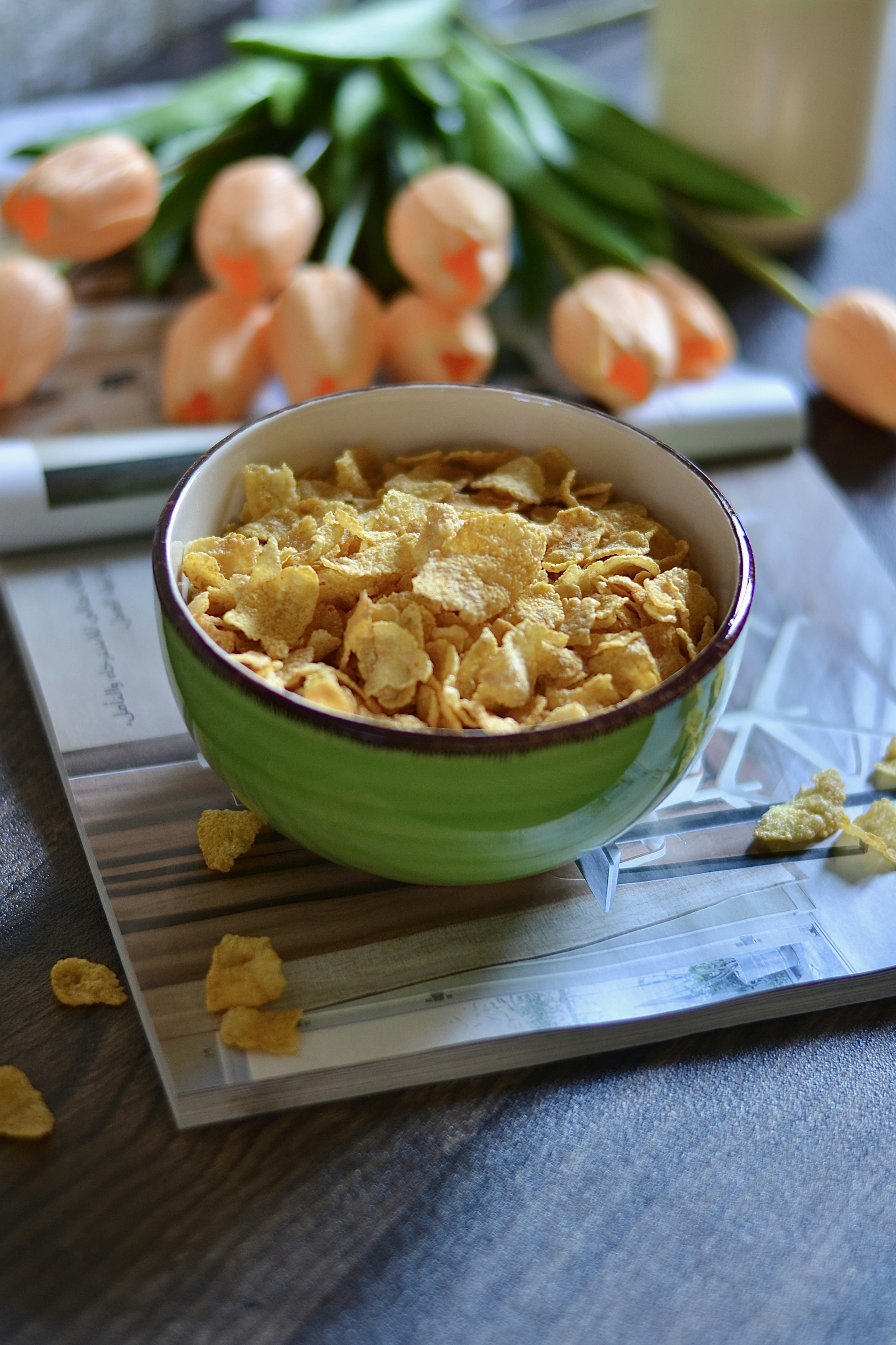A bowl of cornflakes with tulips in the background. photo – Free ...