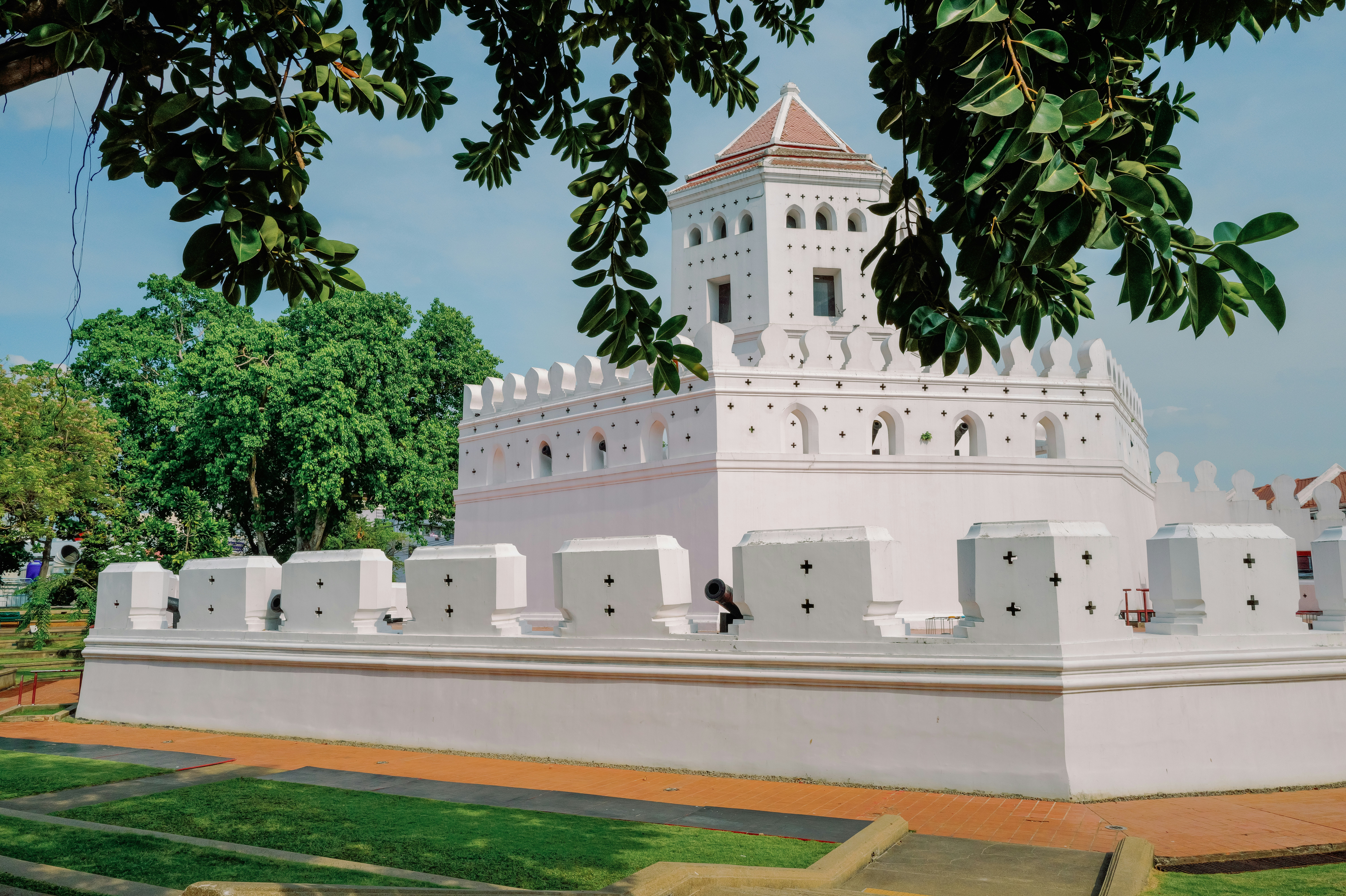 An ancient white fortress stands under greenery. photo – Free Building ...