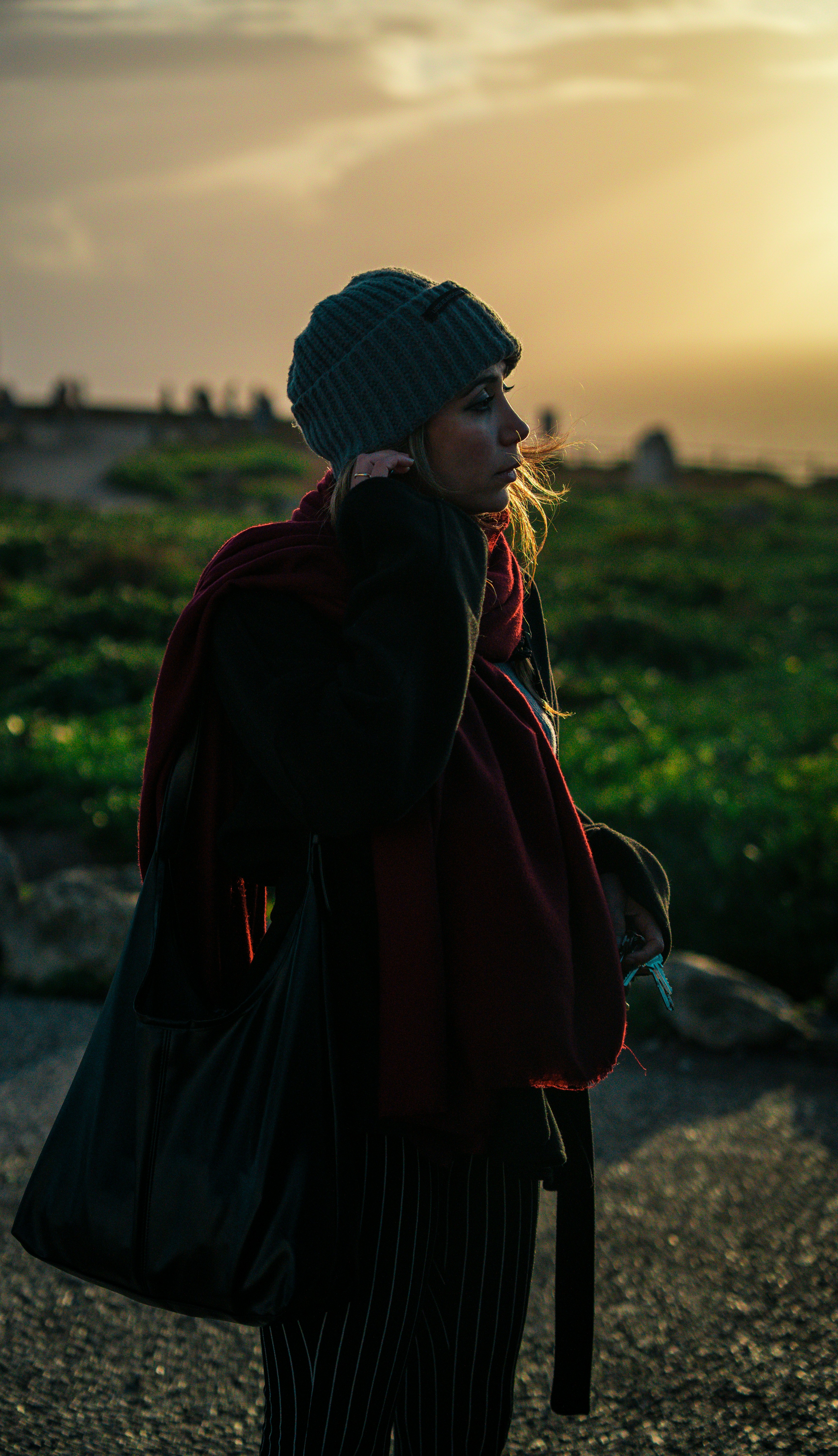 Silhouette in Sunset: A Poised Moment by the Coast