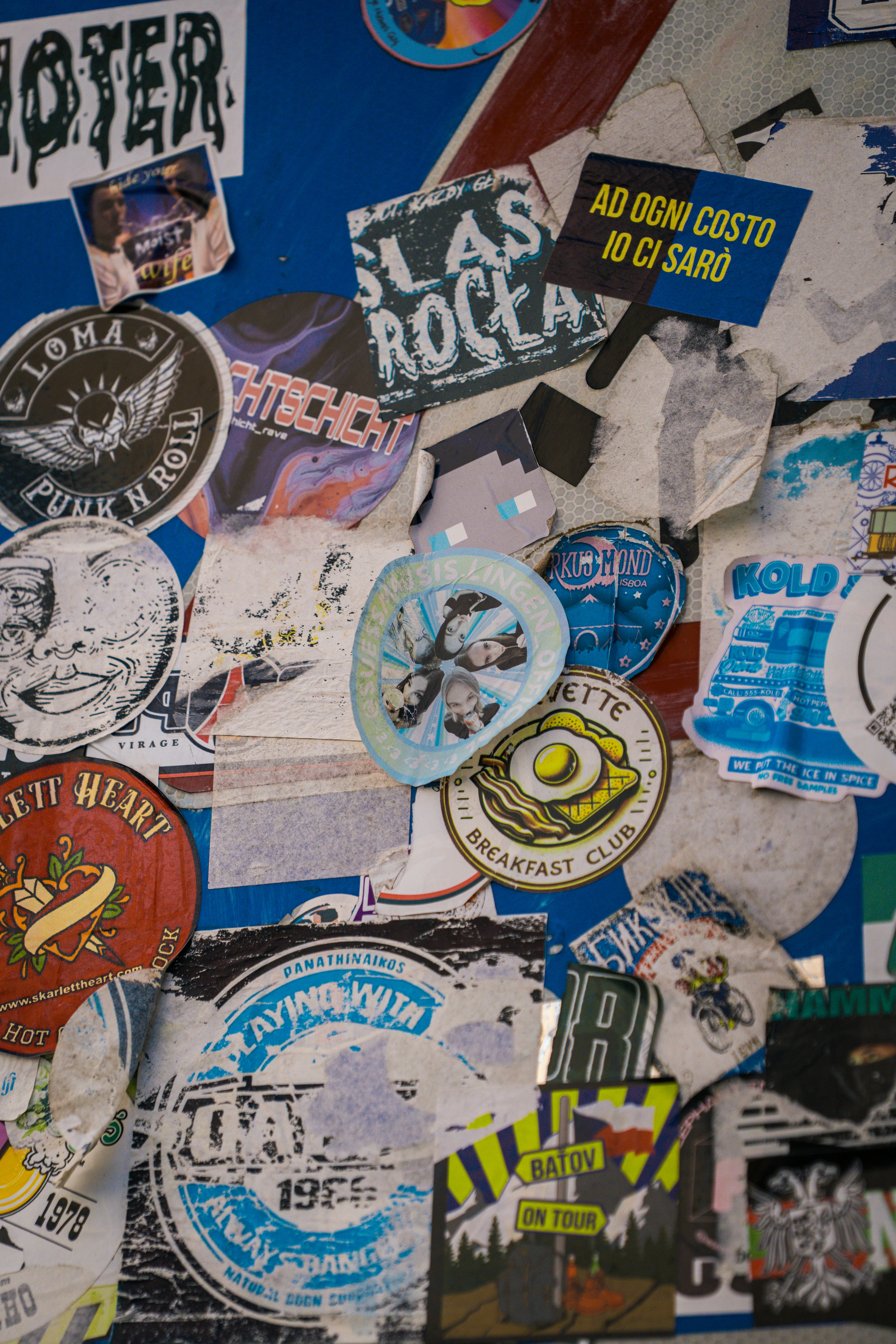 A wall covered in various stickers and labels. photo – Free Woman Image ...