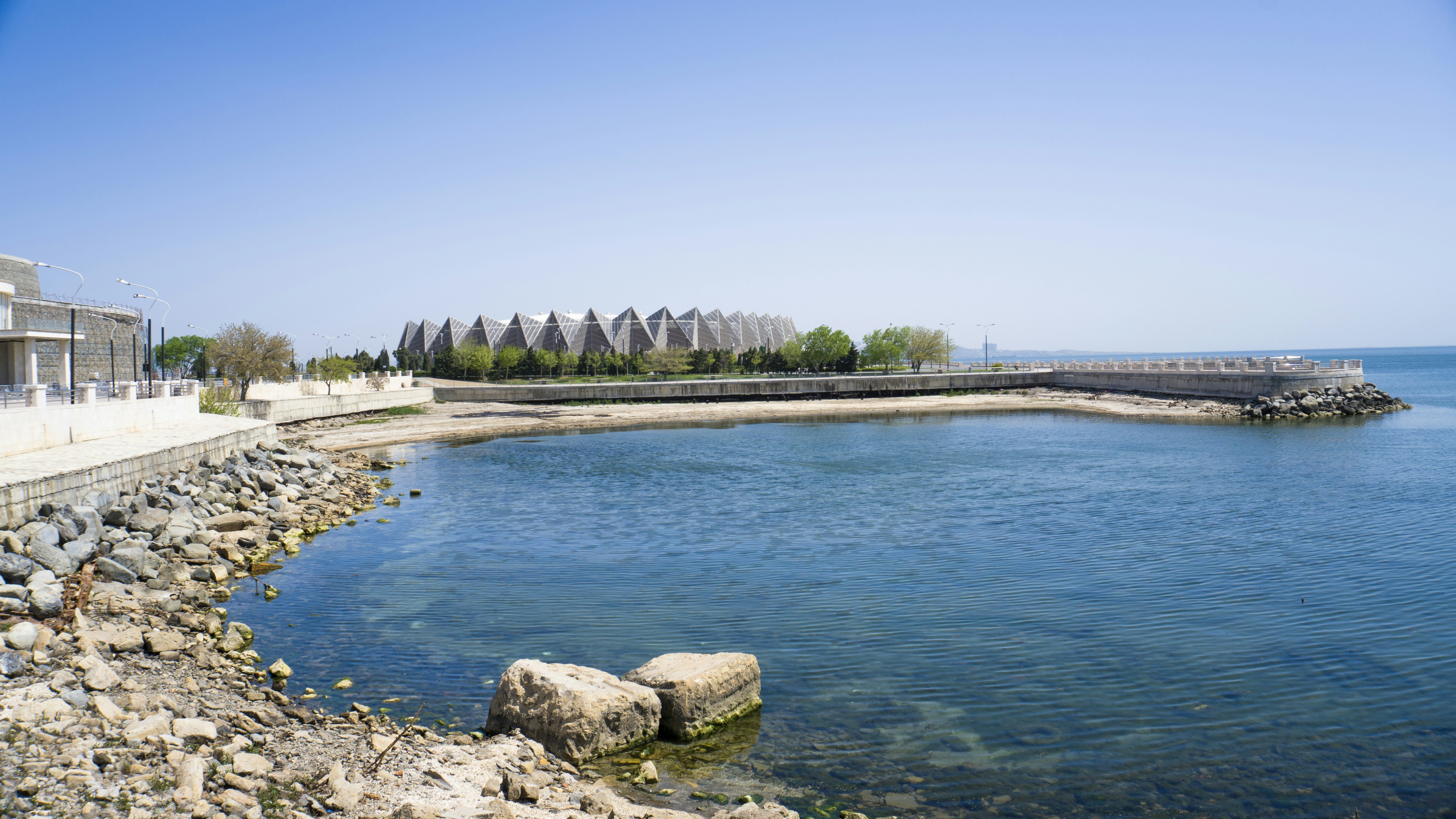 A scenic waterfront with a modern building.