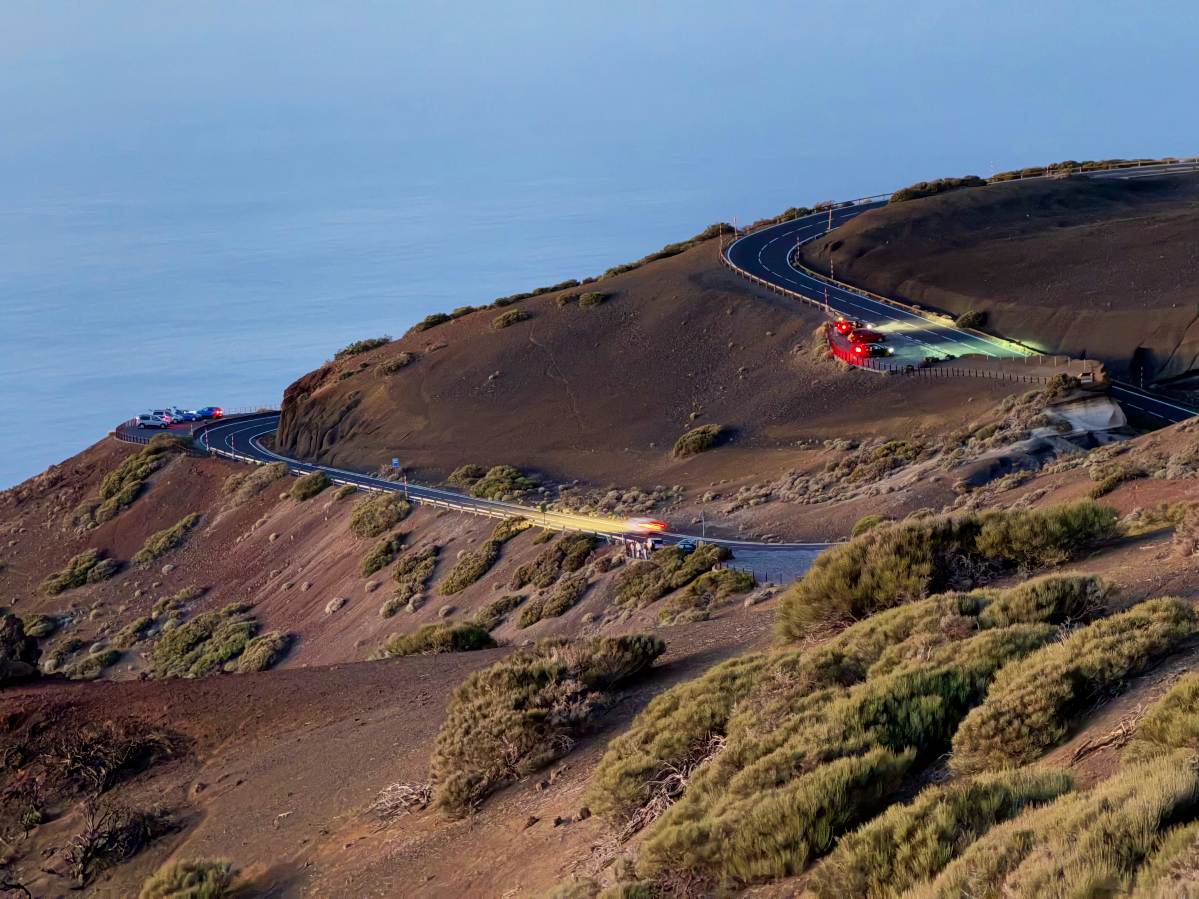 Winding Cliffs: A Ribbon of Road Carries Light Across Volcanic Terrain