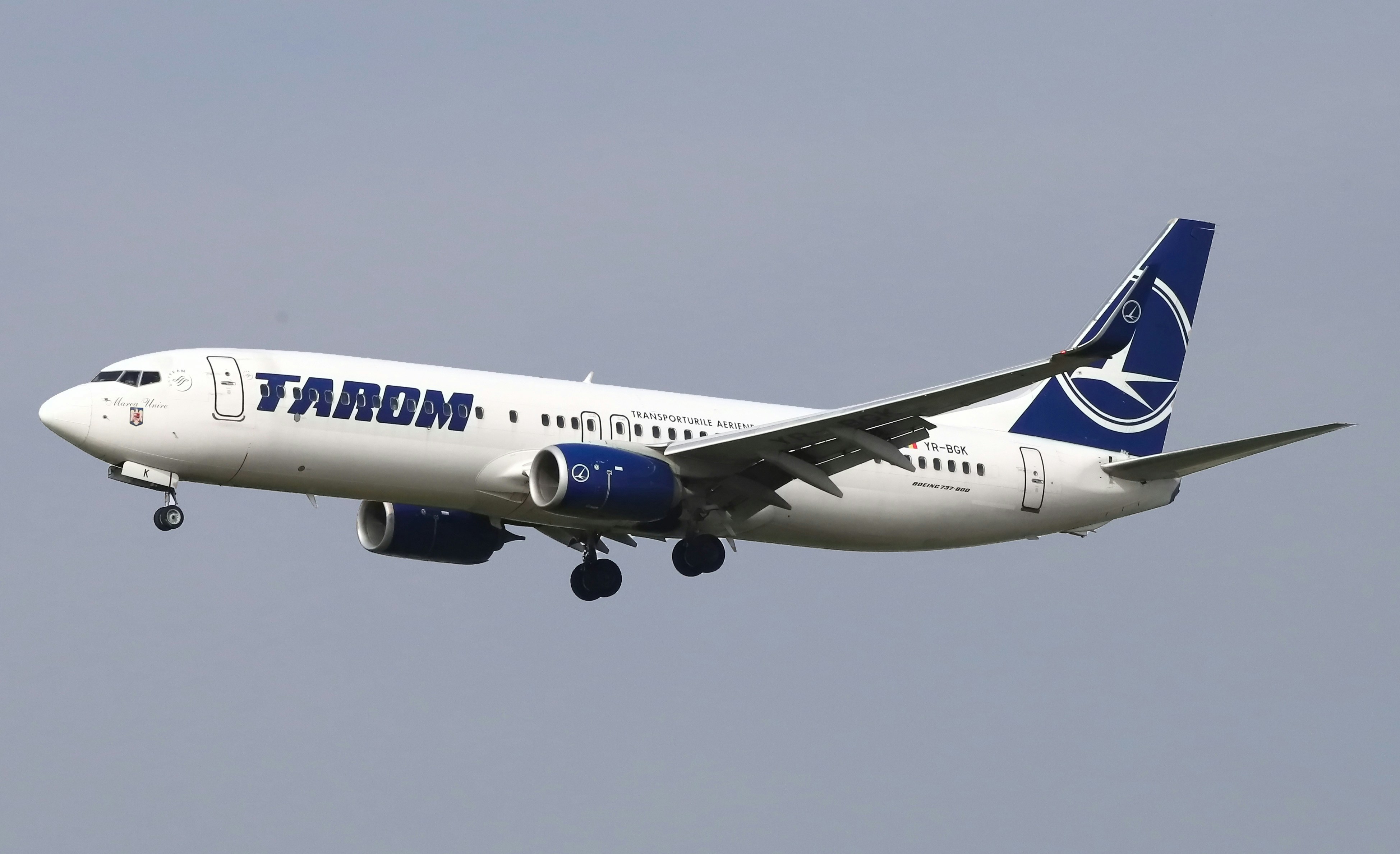 A tarom aircraft is flying in the sky. photo – Free Airplane Image on ...