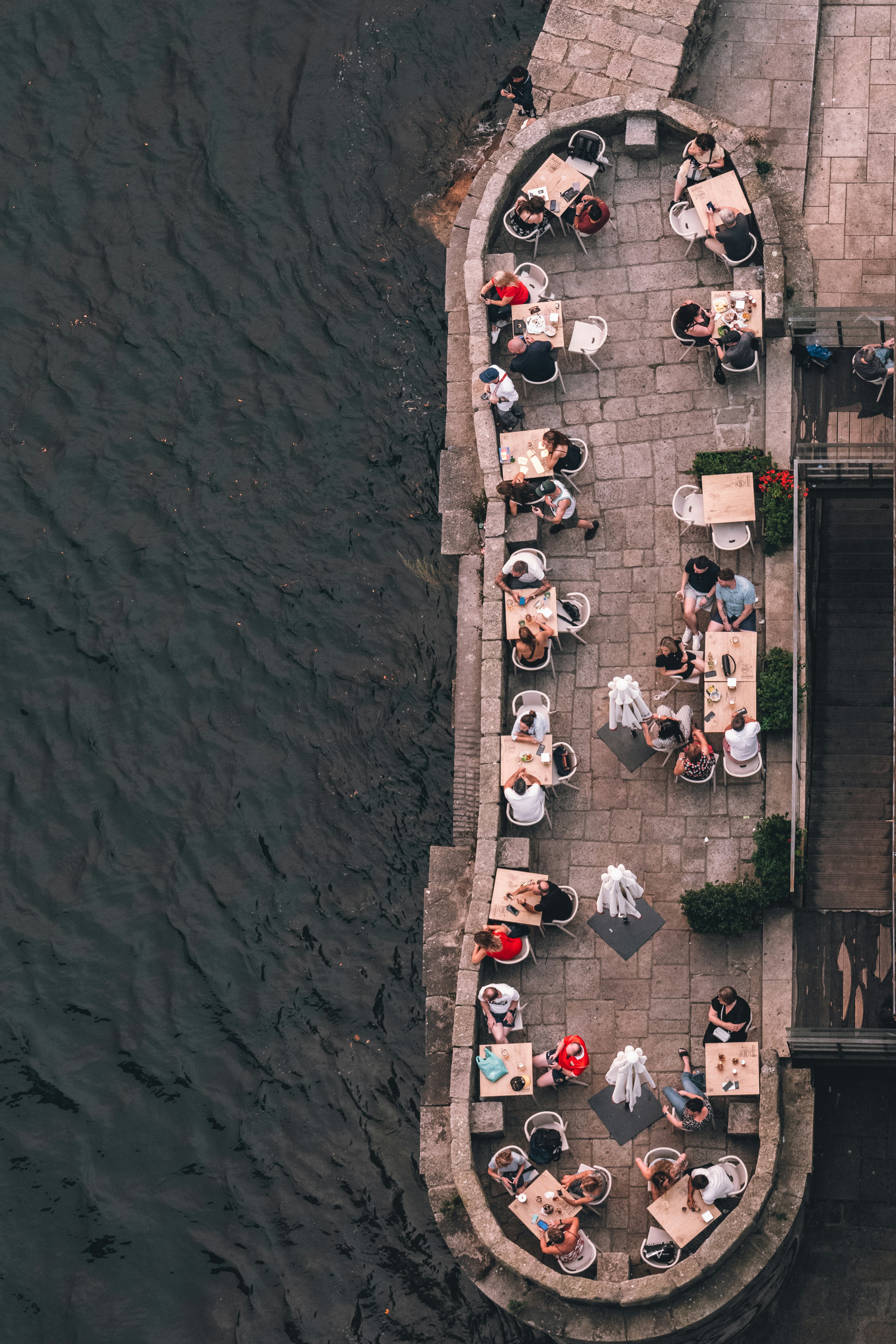 Crescent of Tables: Aerial Al Fresco Dining Along the Waterfront
