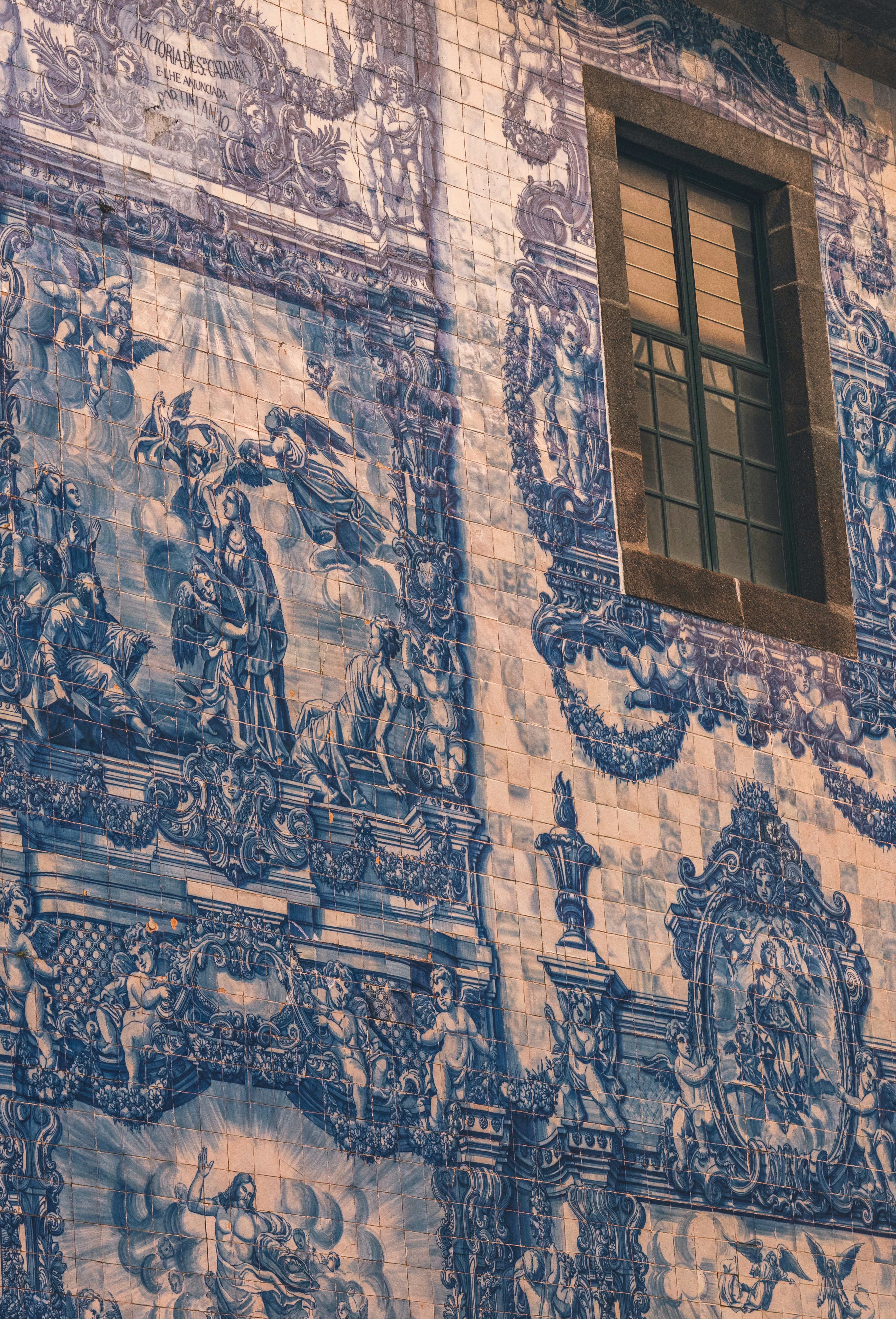 Intricate art with the famous Azulejos (ceramic tiles) on a church wall in Porto, Portugal | Blue and white tiles decorate a church wall.