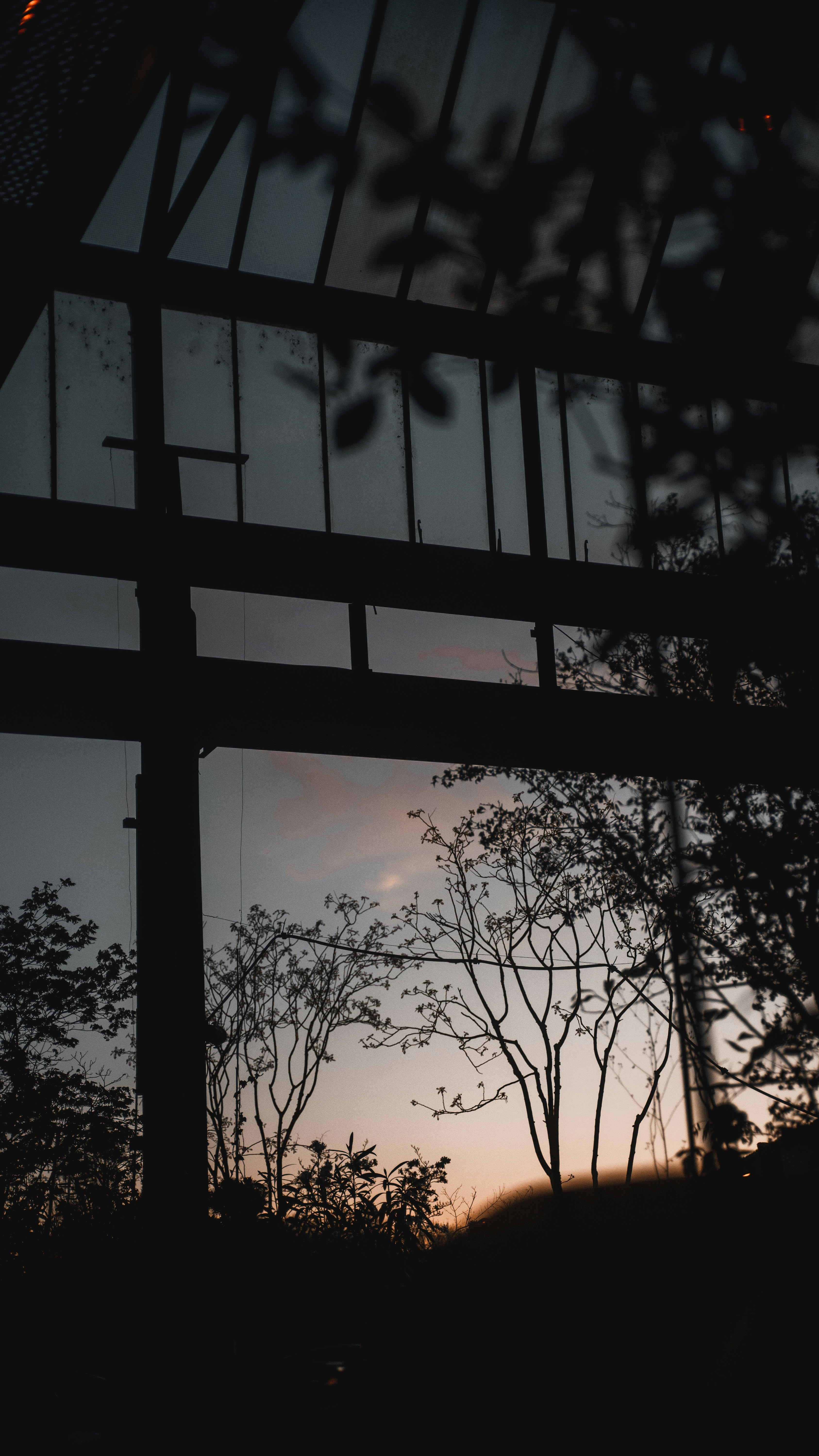 A sunset seen through a window frame. photo – Free Building Image on ...