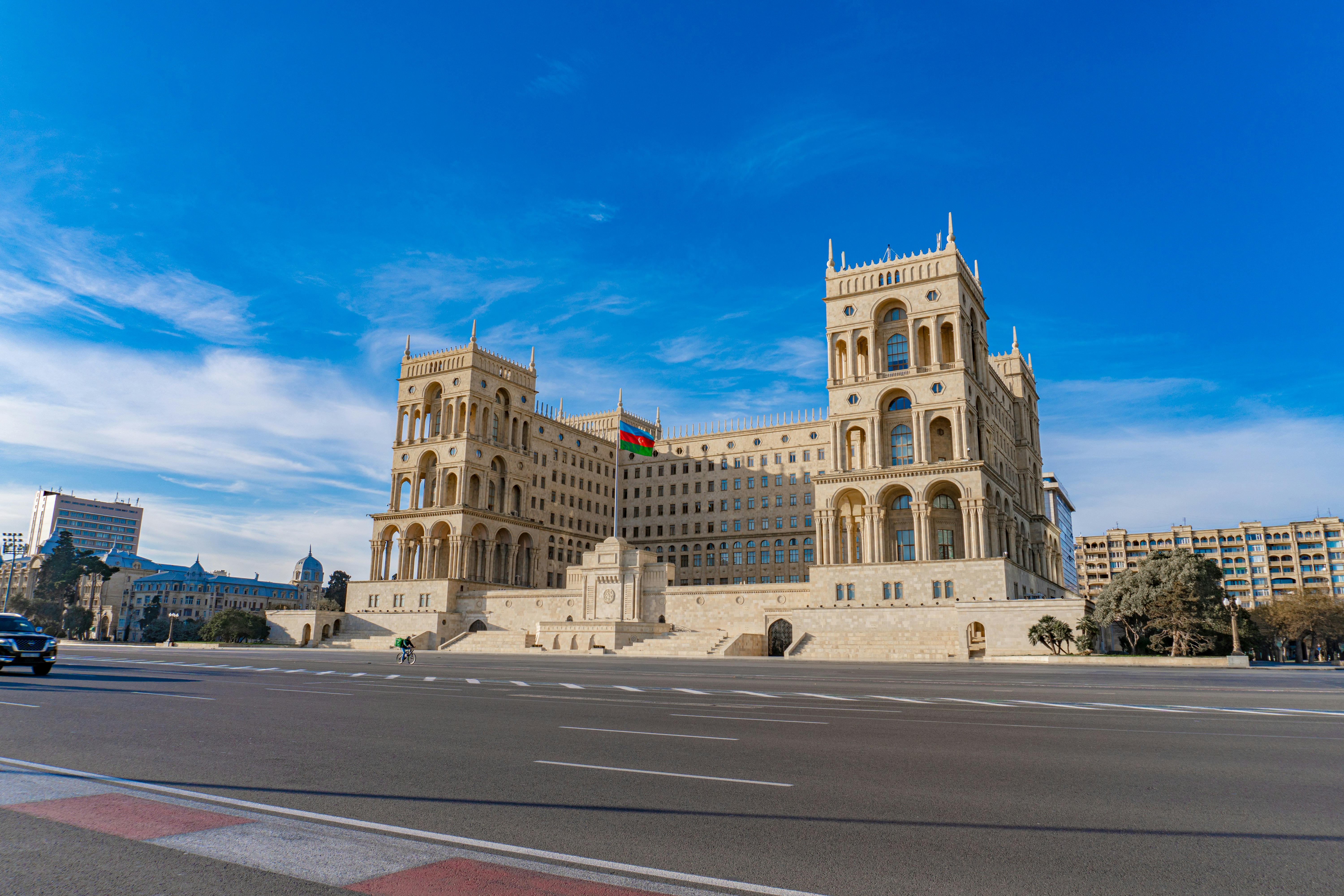 A large, elaborate building stands beneath a blue sky. photo – Free Car ...