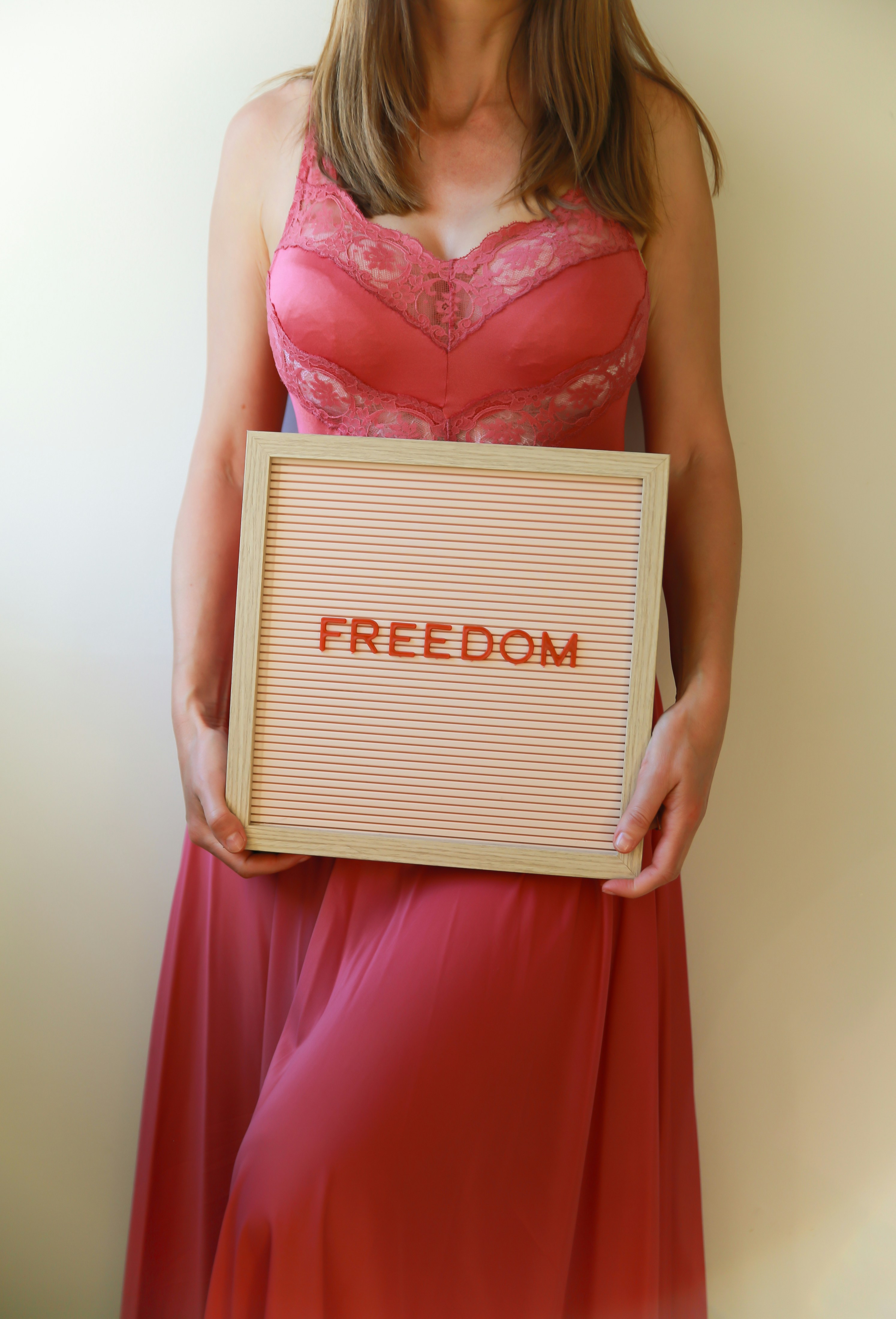 Woman holds sign that reads "freedom." photo – Free Woman Image on Unsplash