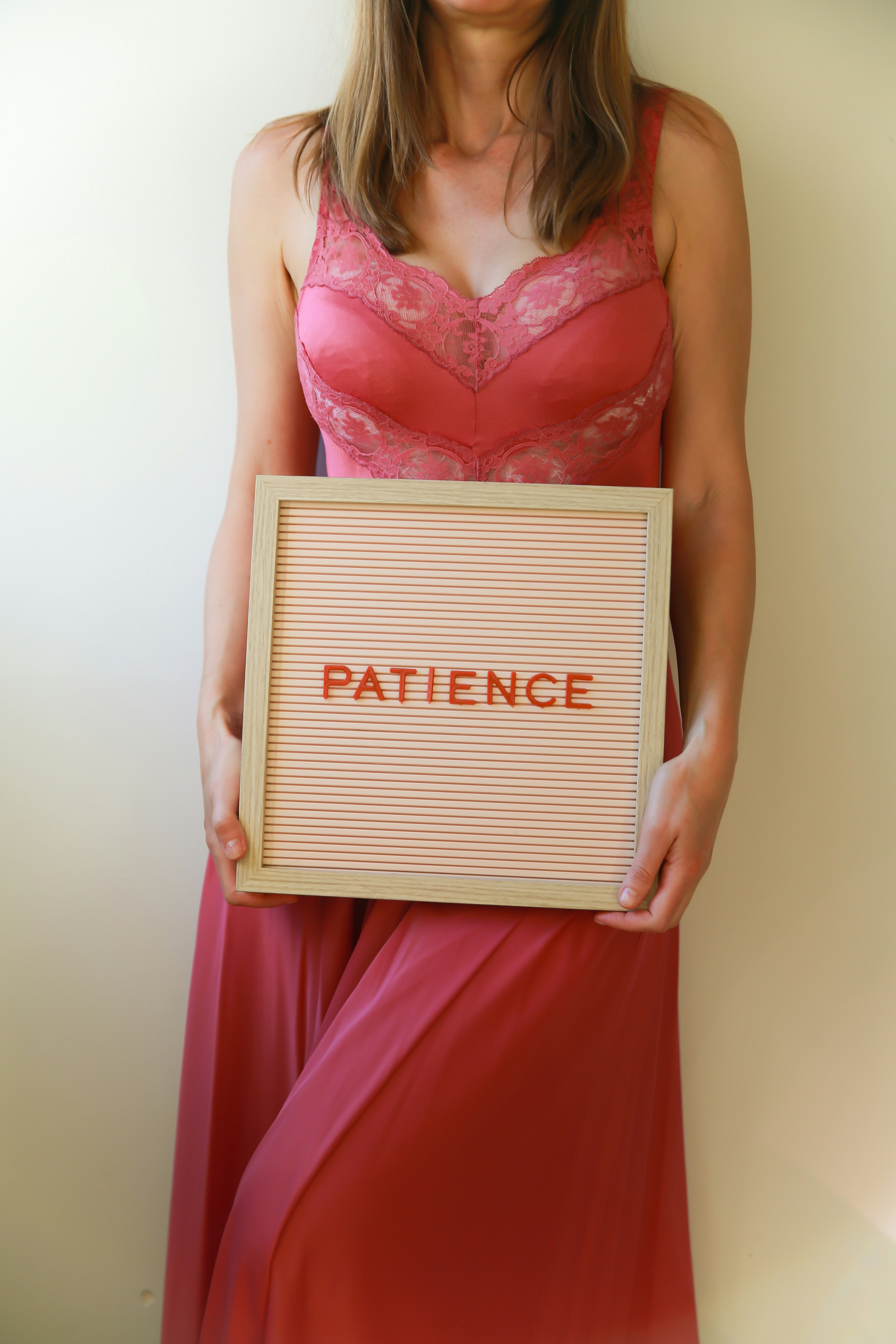 A woman holds a sign that reads "patience." photo – Free Woman Image on ...