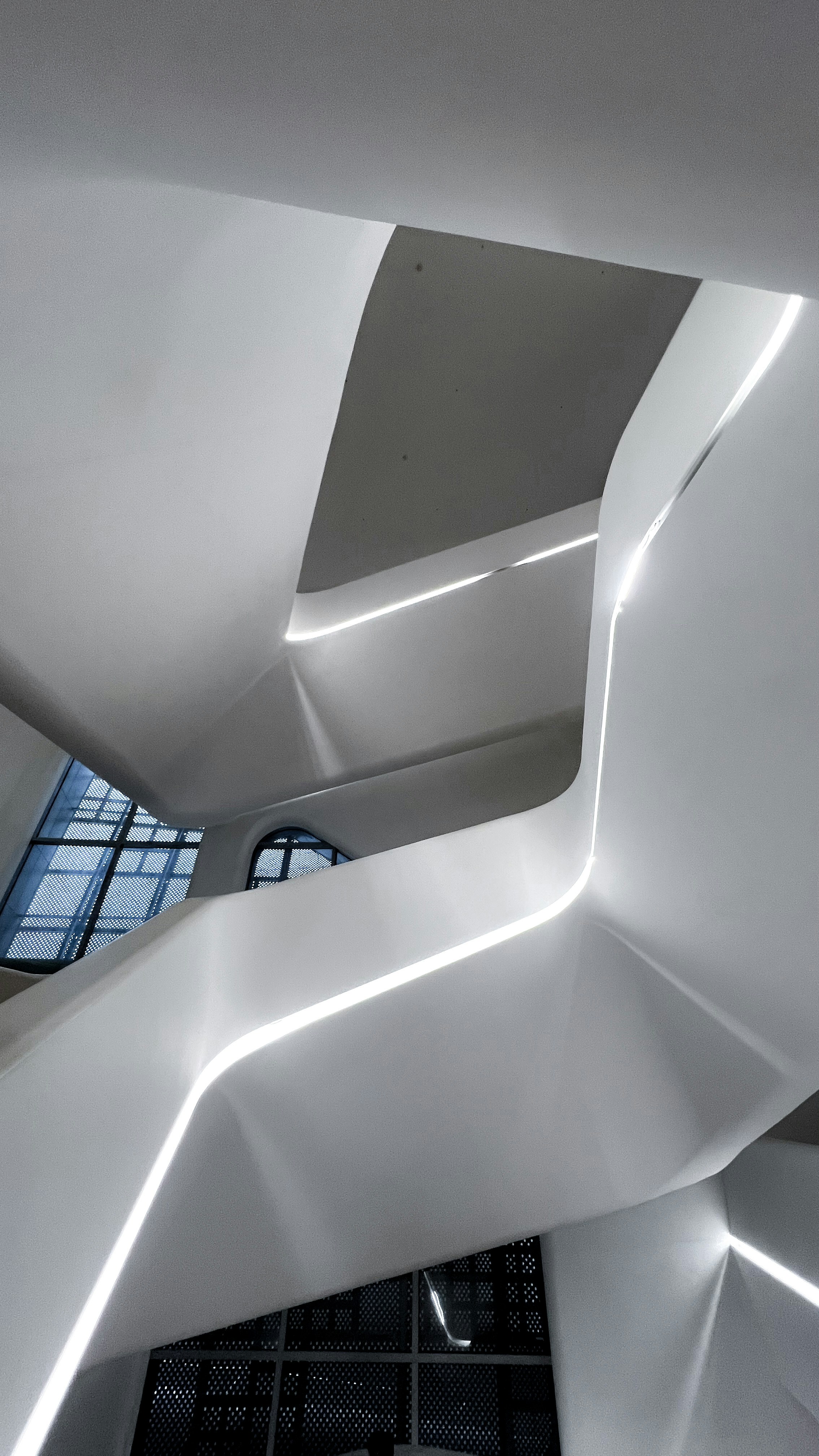 Modern architecture with white curves and integrated lighting. photo ...
