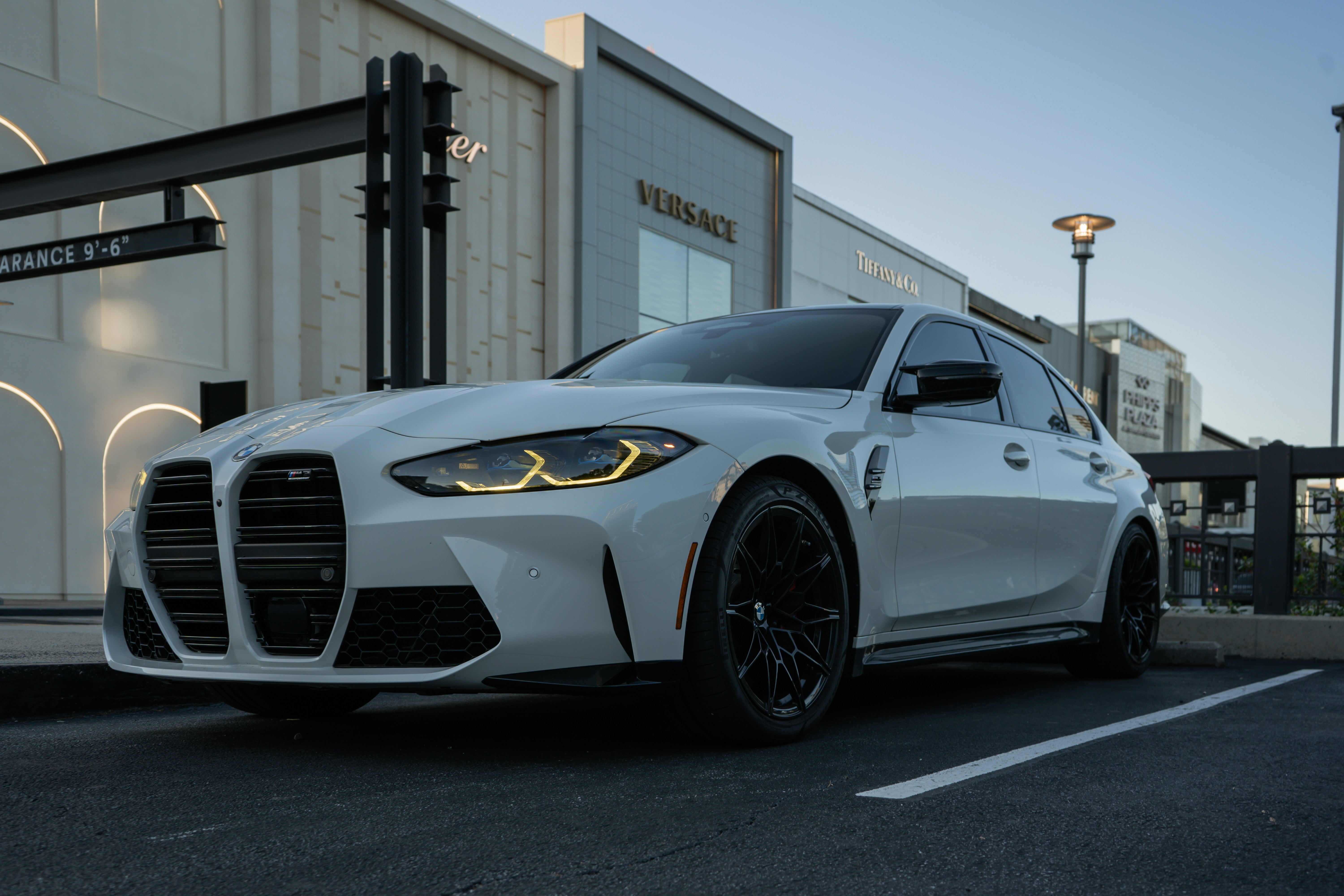 A white BMW is parked outside a versace store. photo – Free Car Image ...