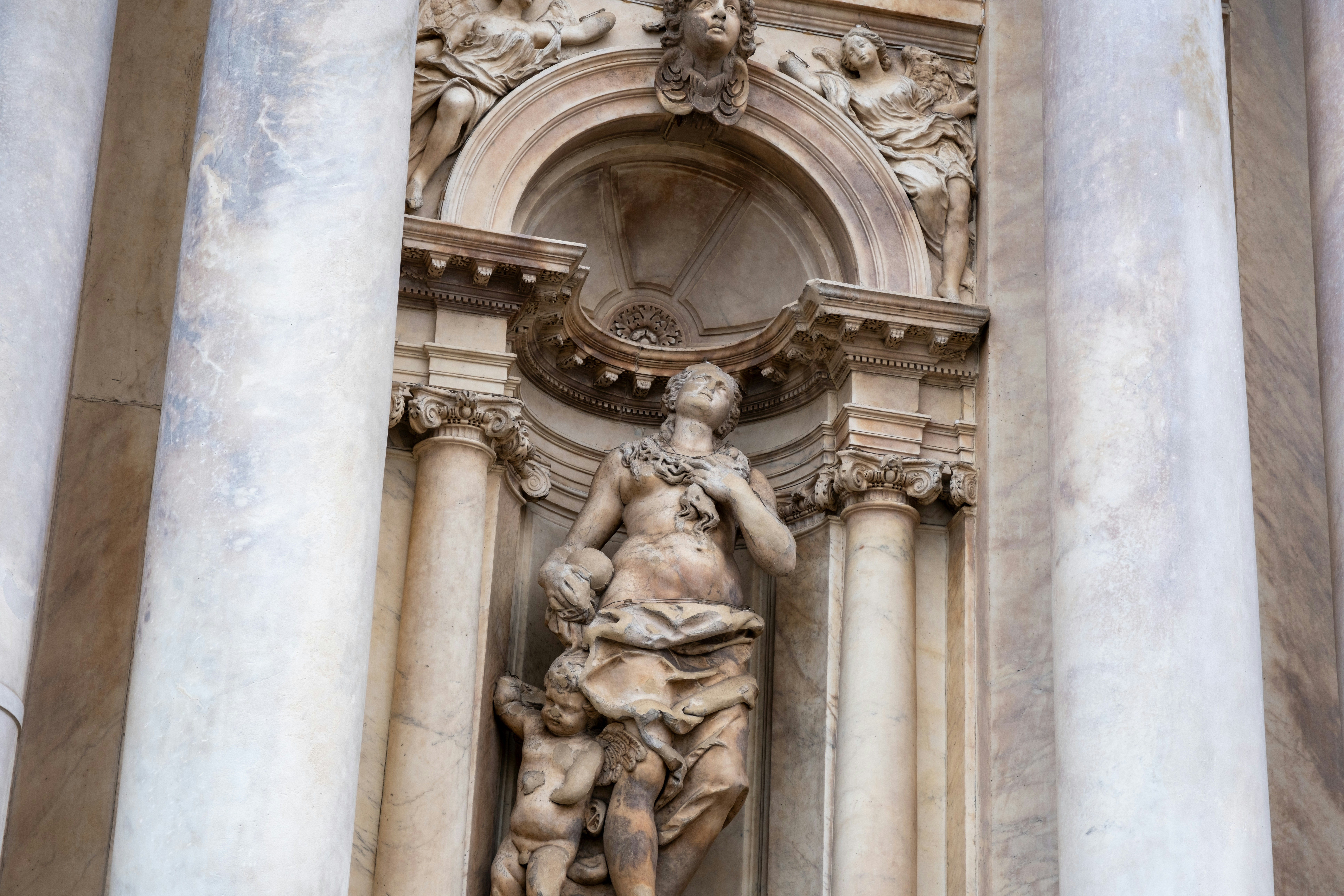 A detailed statue is depicted within arched columns. photo – Free Woman ...