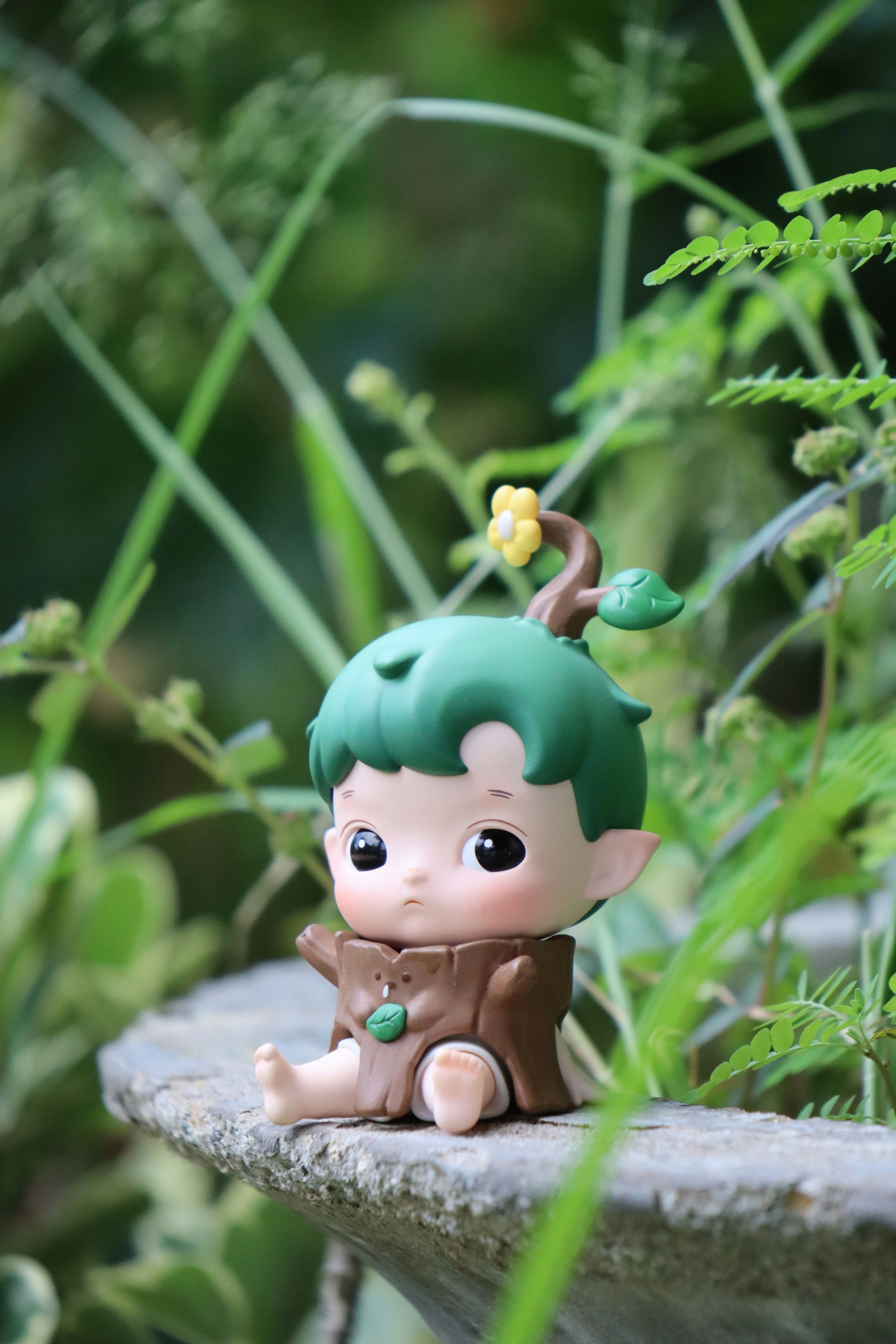 A cute forest creature figurine sits amongst greenery. photo – Free ...
