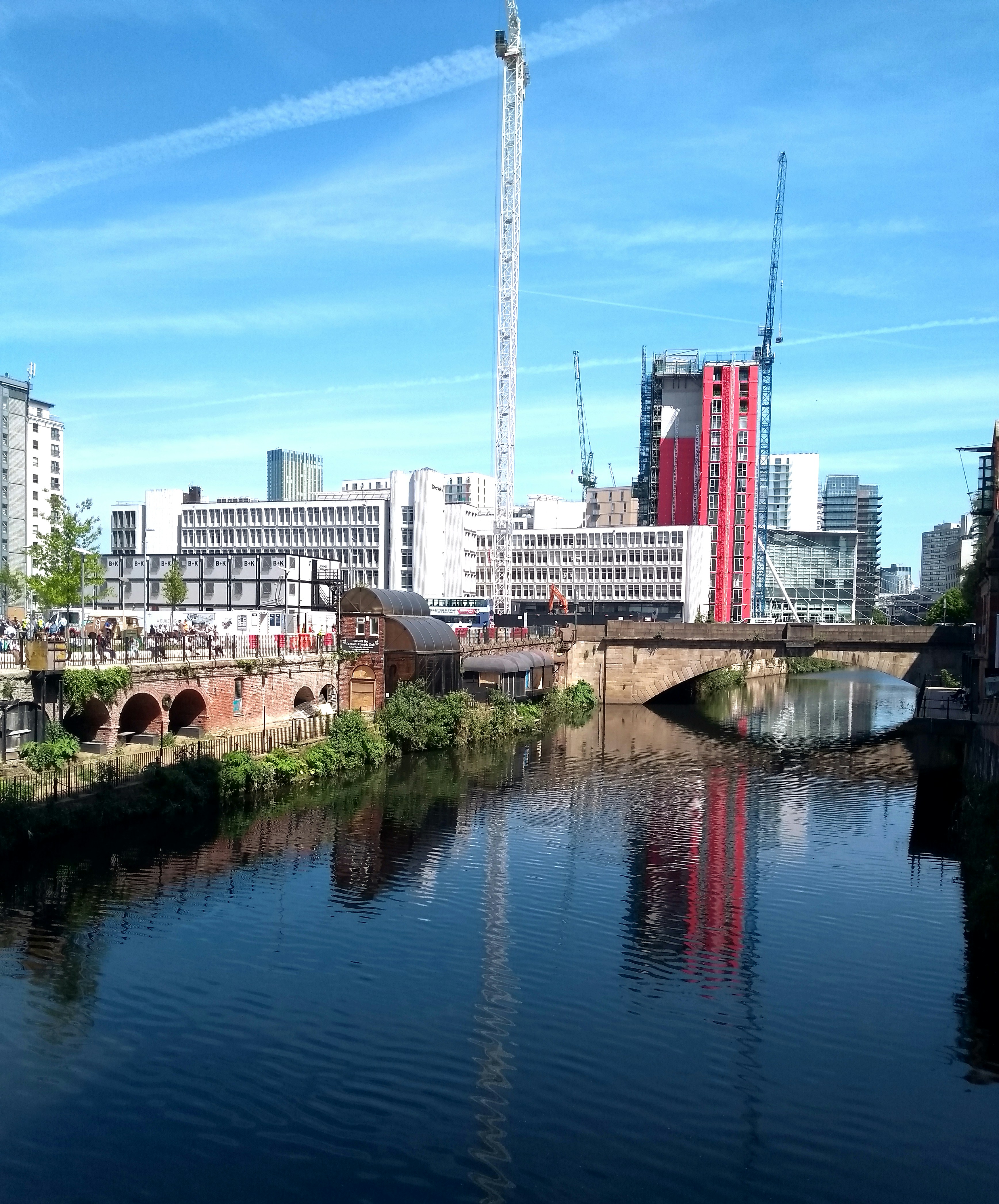 City buildings are reflected in the calm river. photo – Free ...