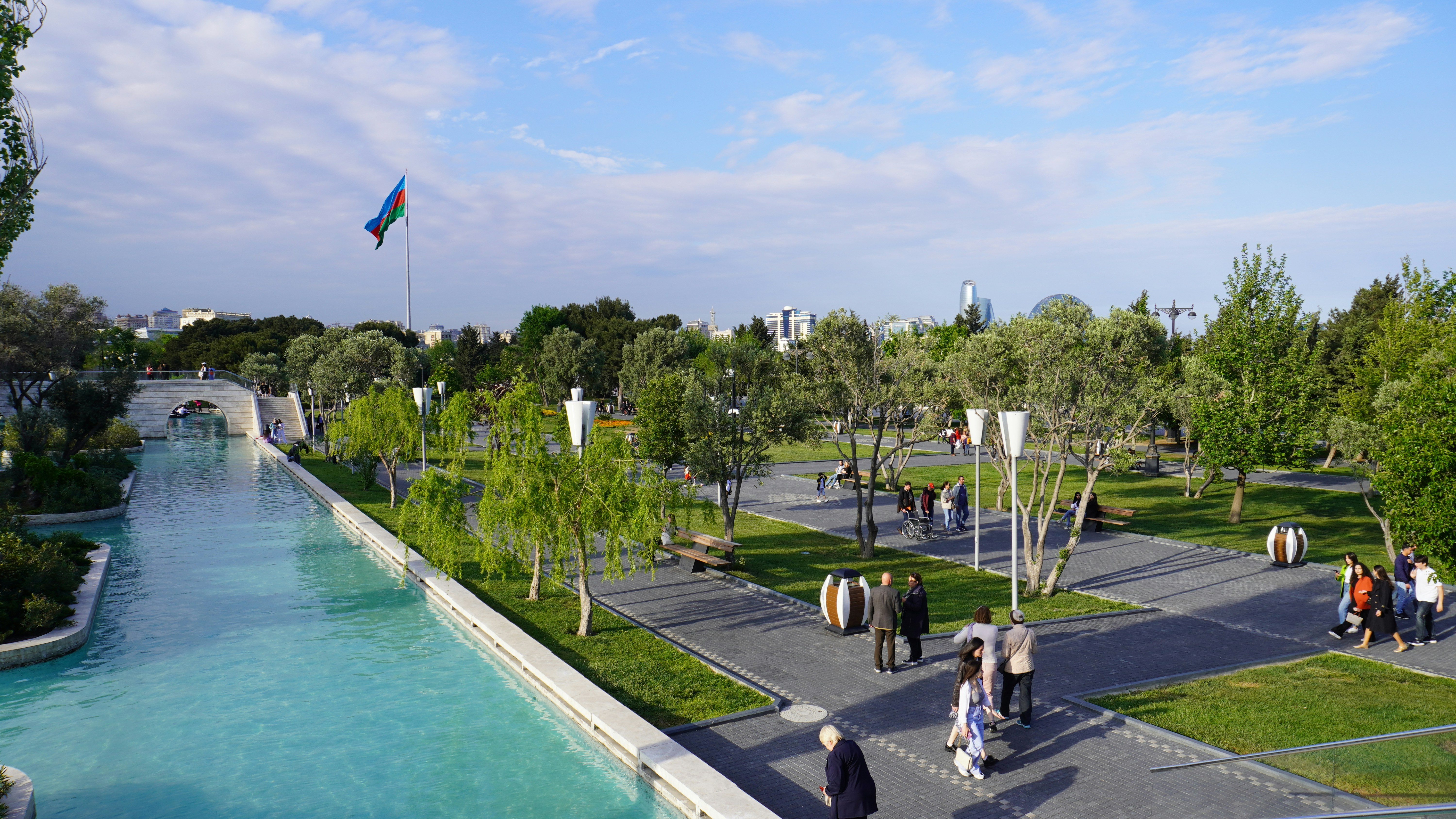 A beautiful park with a waterway and flag. photo – Free Human Image on ...