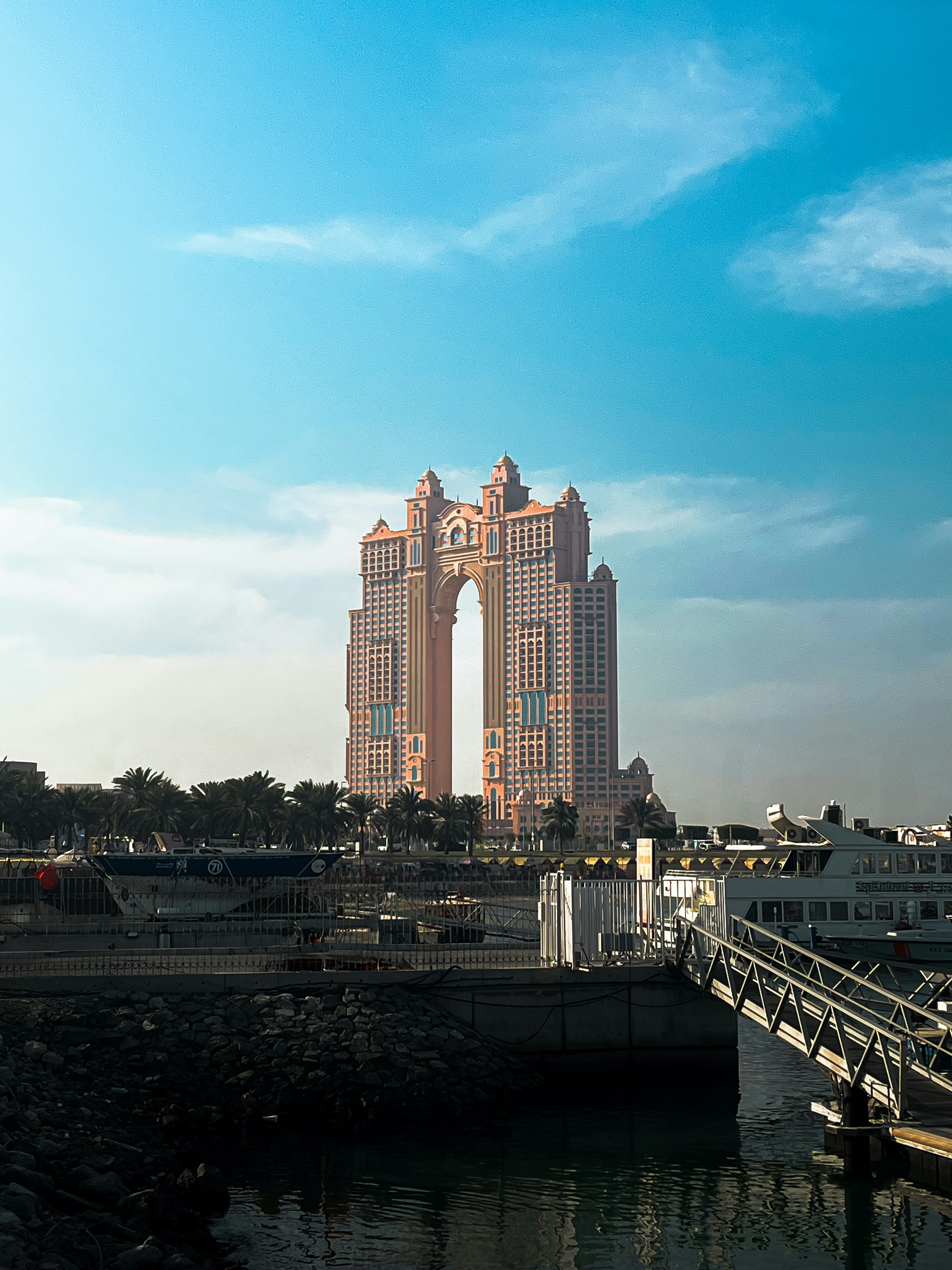 A tall building with an archway stands proudly. photo – Free City Image ...