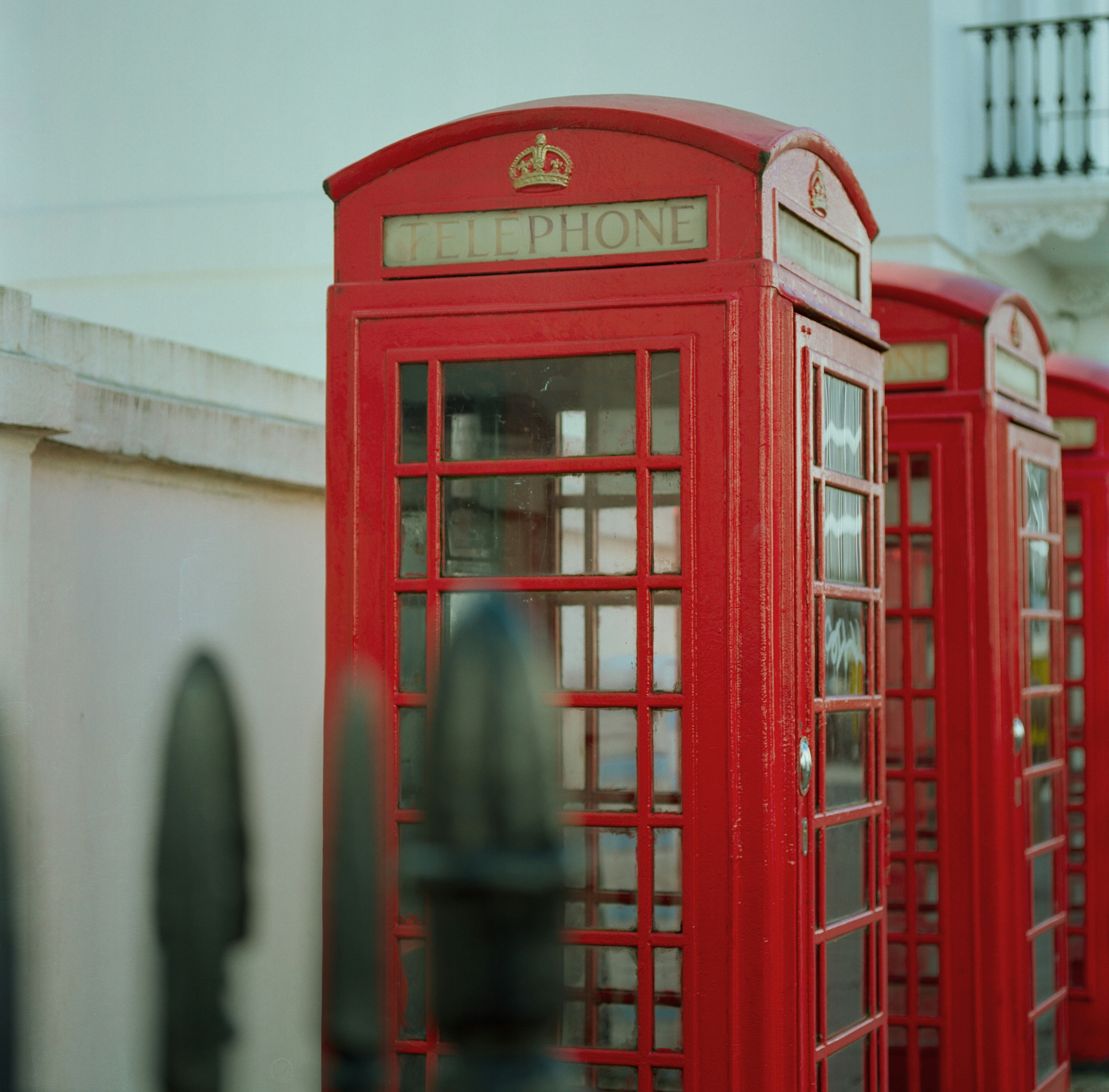Red british phone booths stand in a row. photo – Free Phone booth Image ...