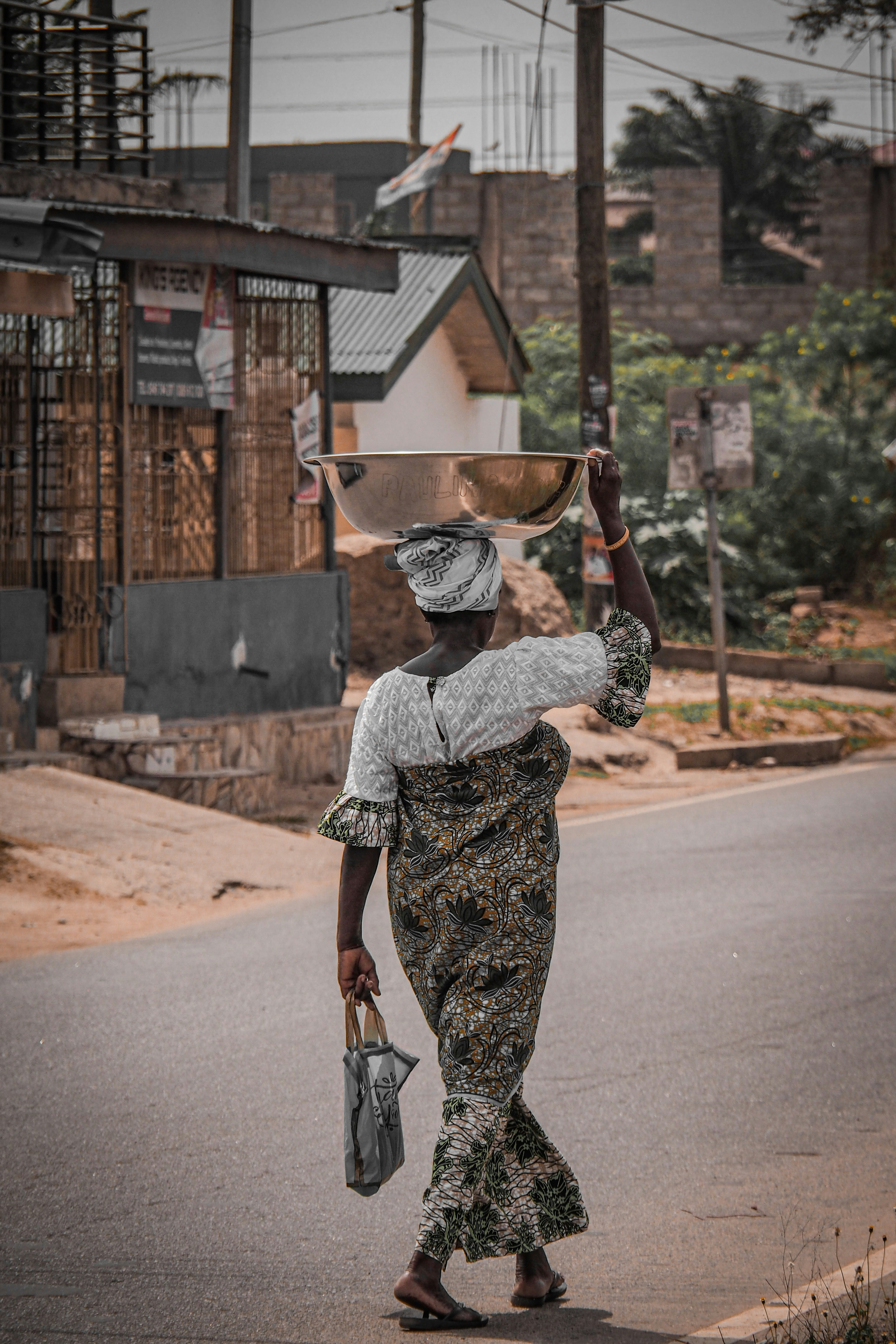 Basin-Balancing Portrait on a Dusty Town Street