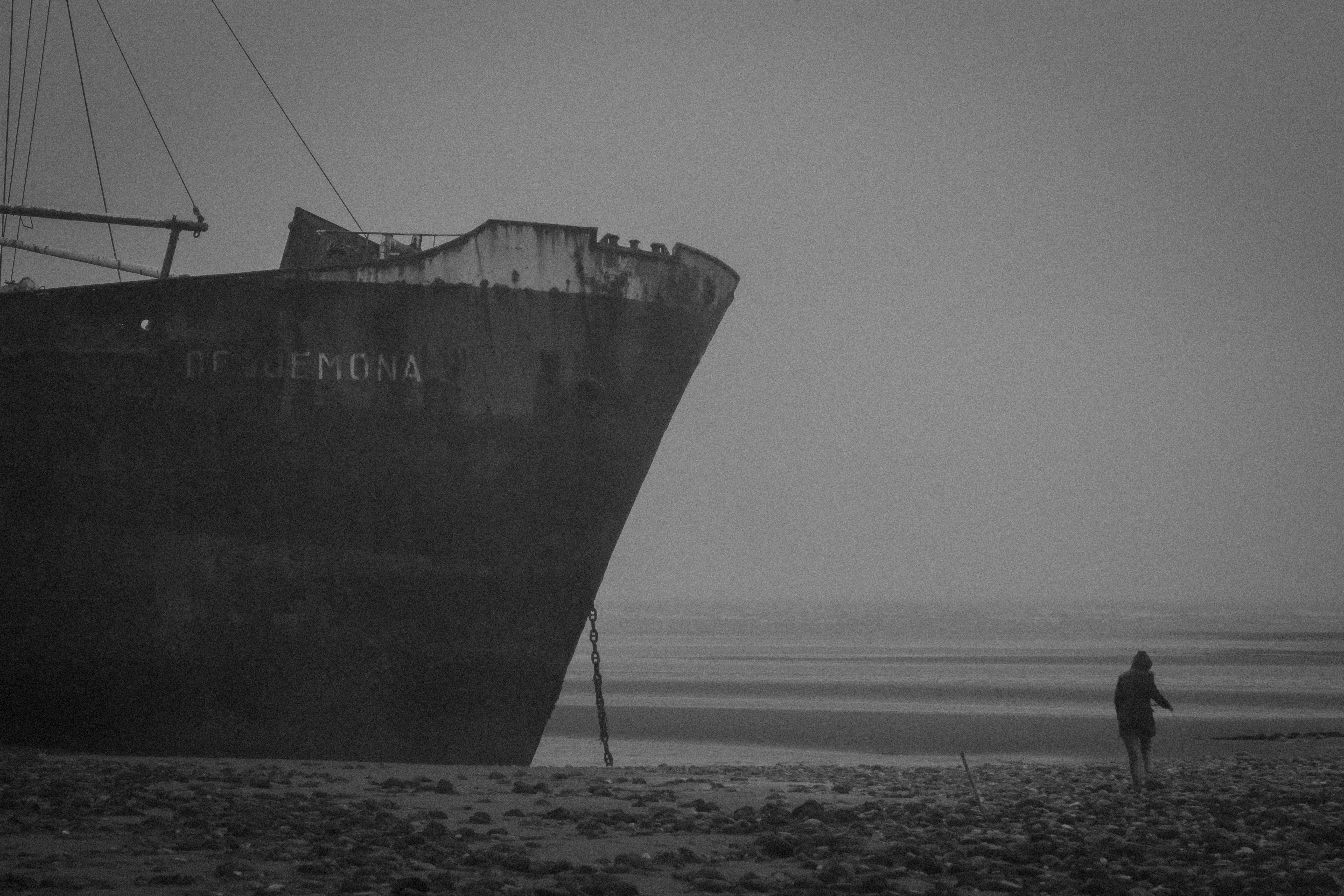 The Rusted Bow on a Fogbound Shore and the Lone Figure