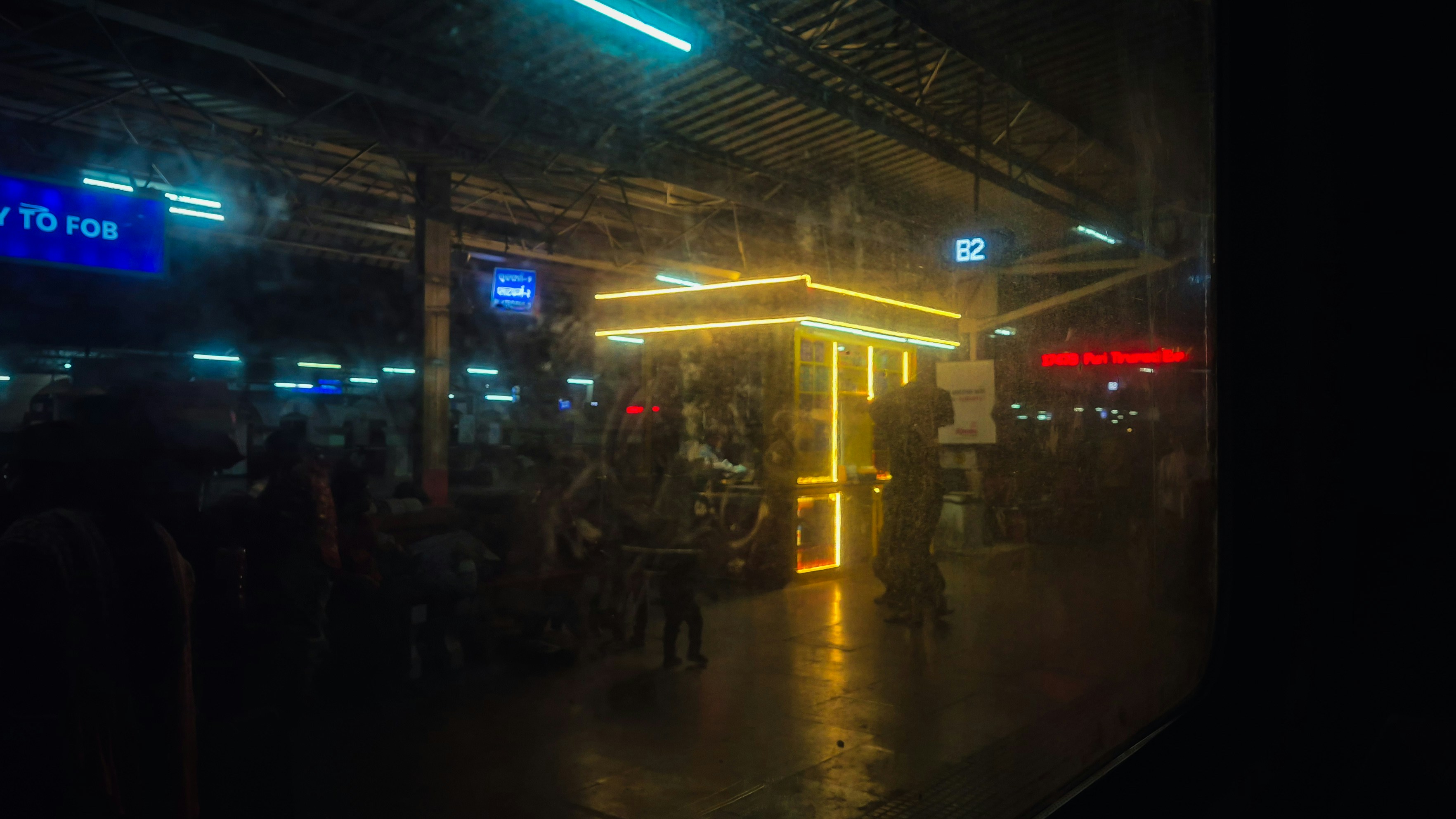 Neon silhouettes at the transit terminal