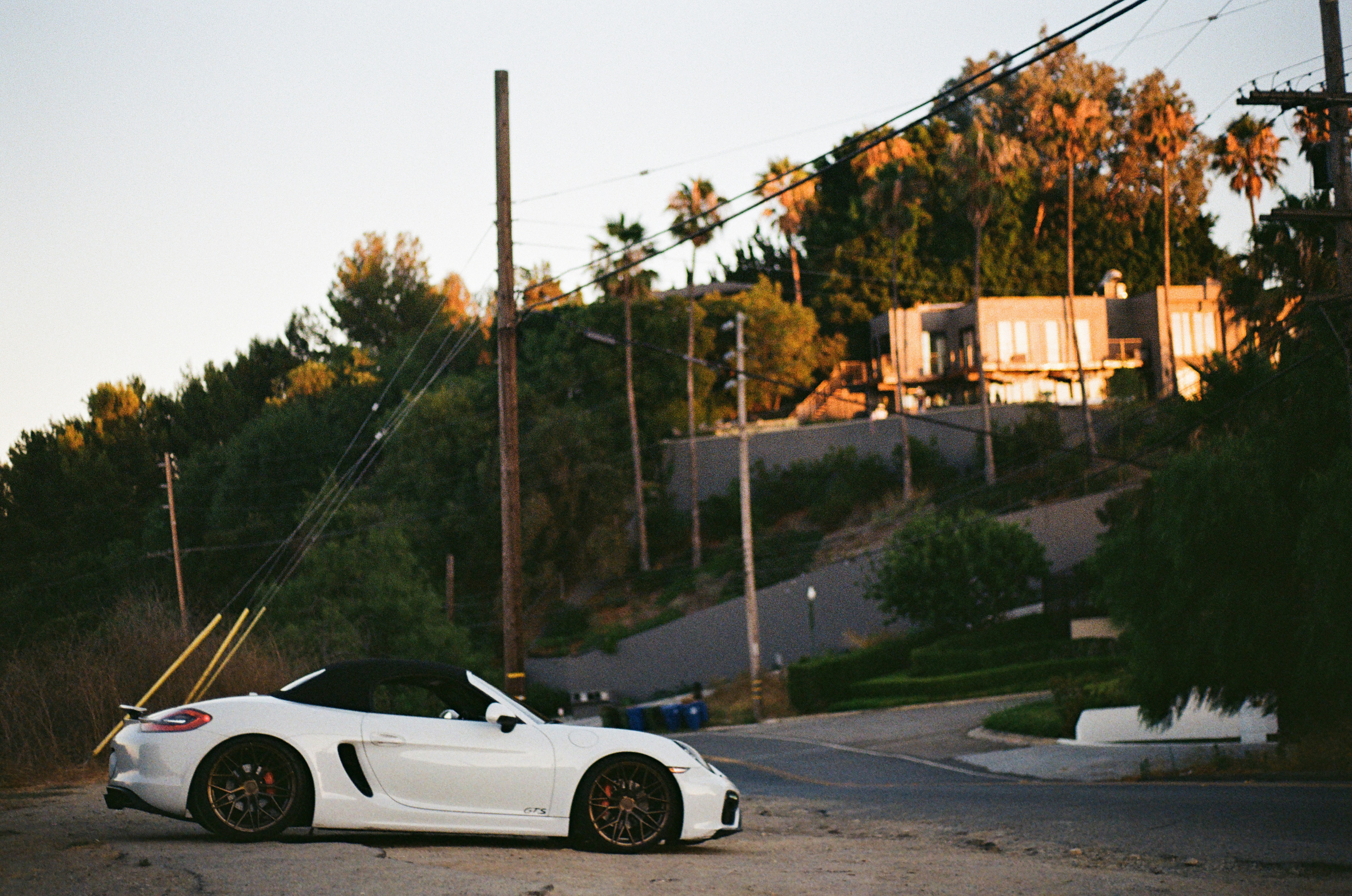 Sunlit White Roadster on a Quiet Hillside Backroad at Golden Hour