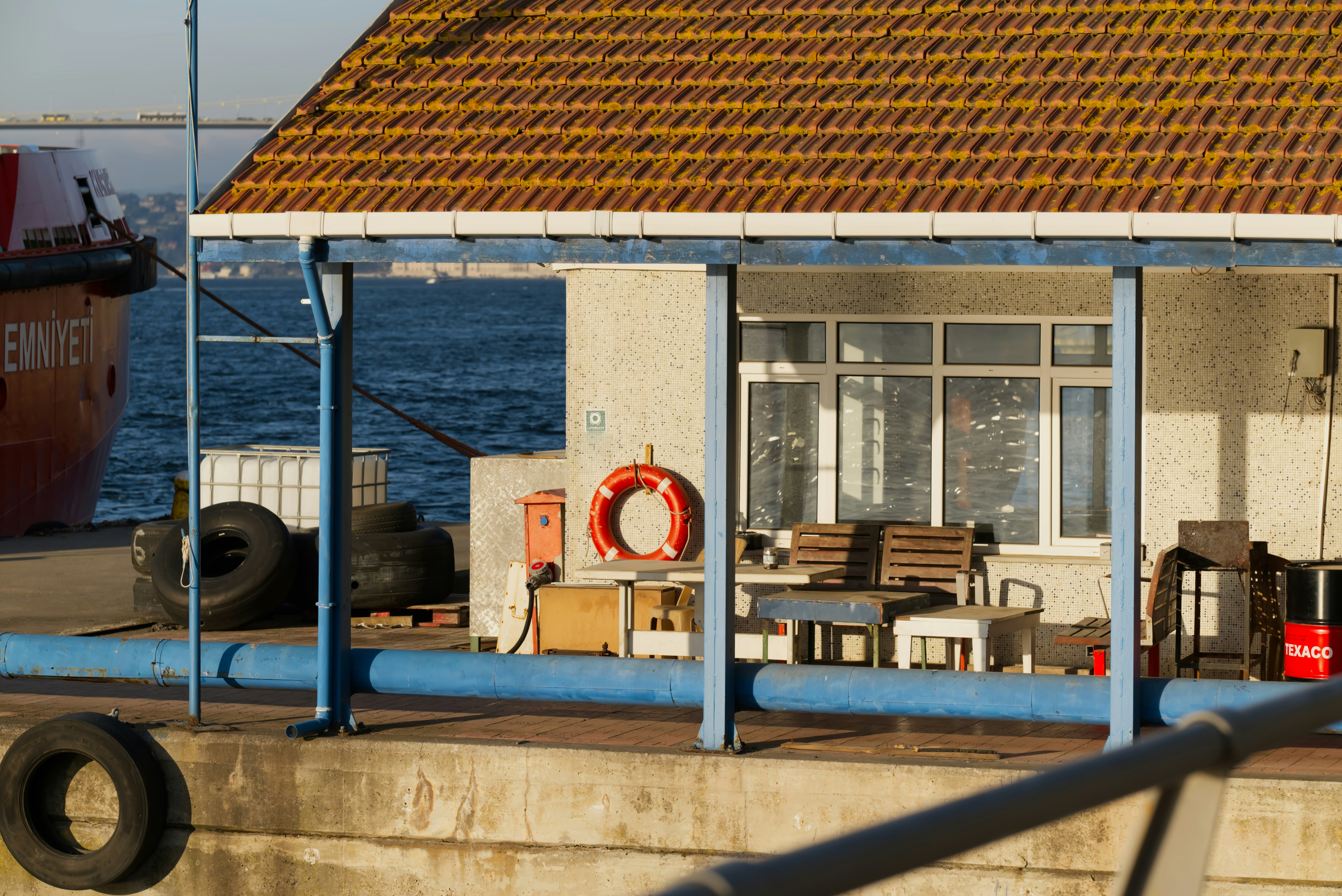Lifebuoy and Quiet Harbor: A Sunlit Dock at Dusk