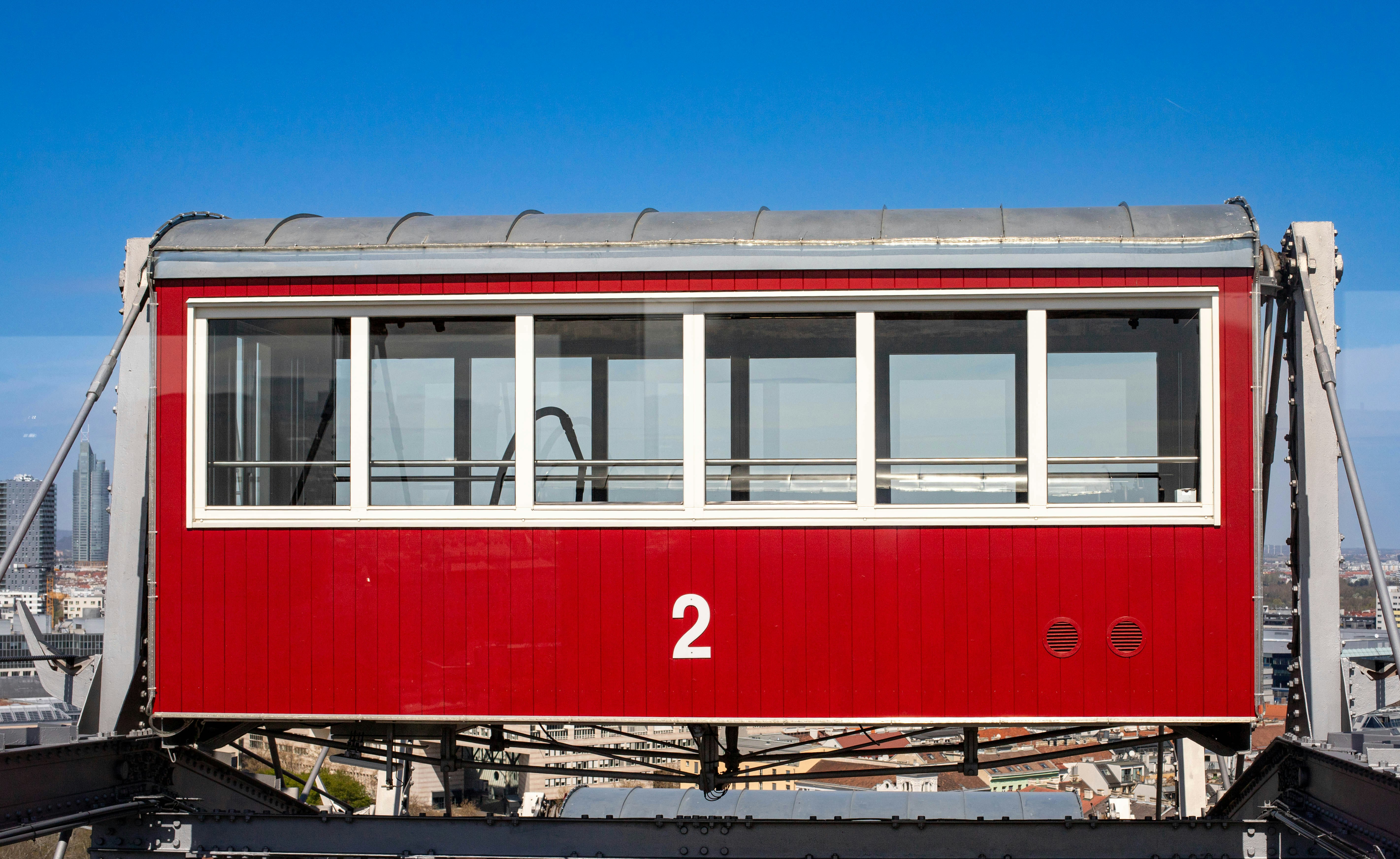 Crimson Gondola on a Skybridge Framing the City