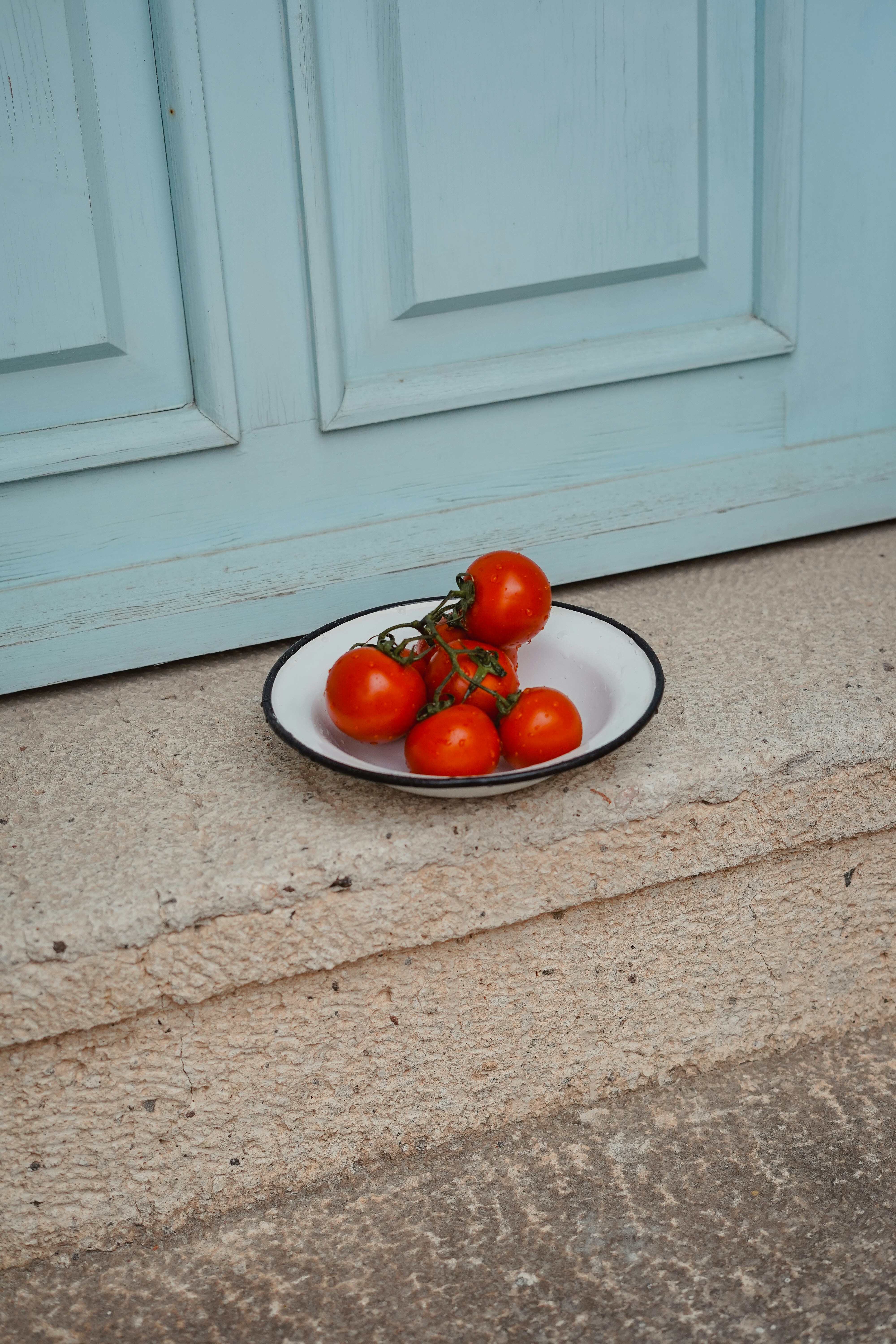 Tomatoes at the Threshold: a Simple Still Life by a Pastel Blue Door