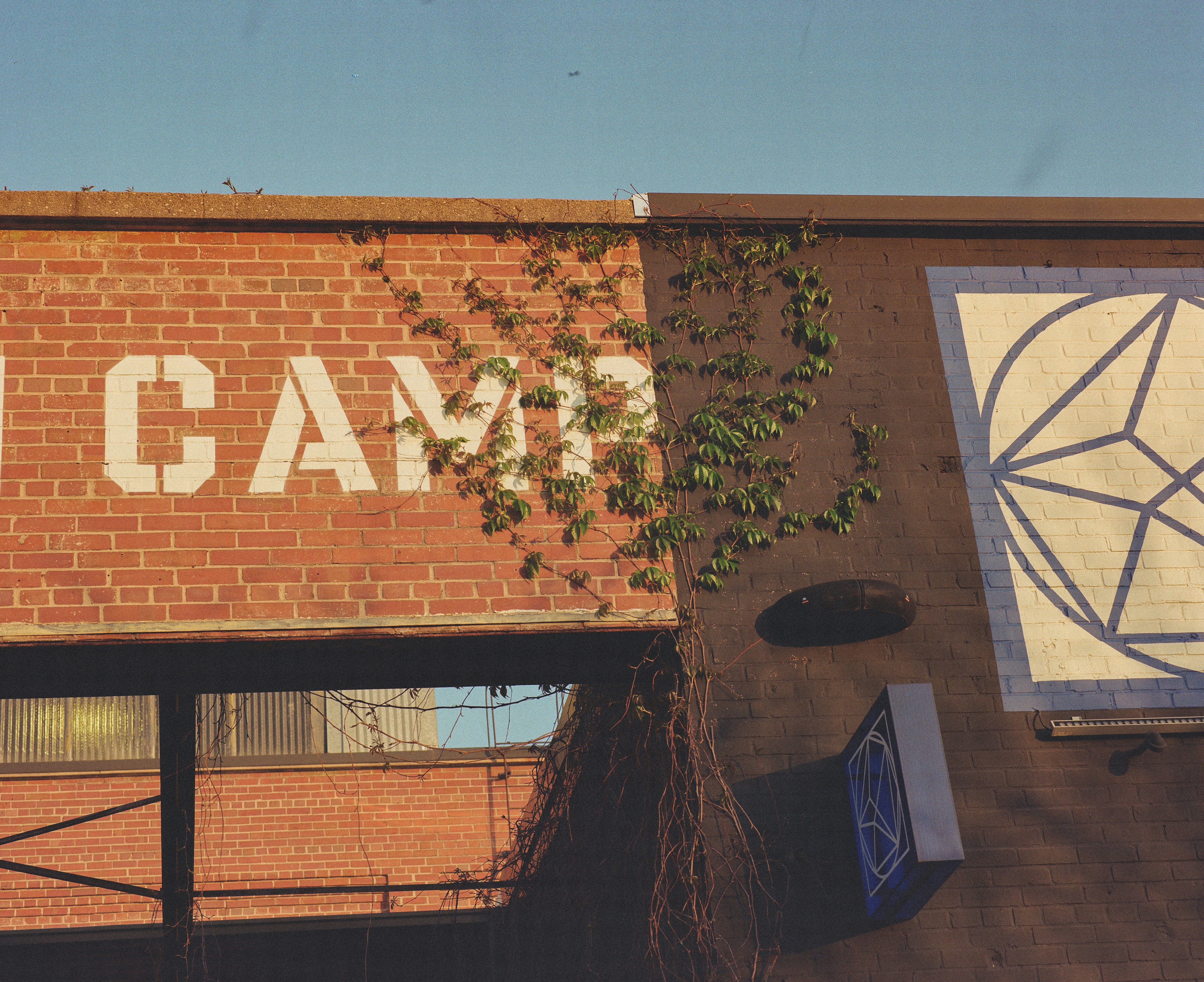 An old building with "camp" lettering and murals. photo – Free Building ...