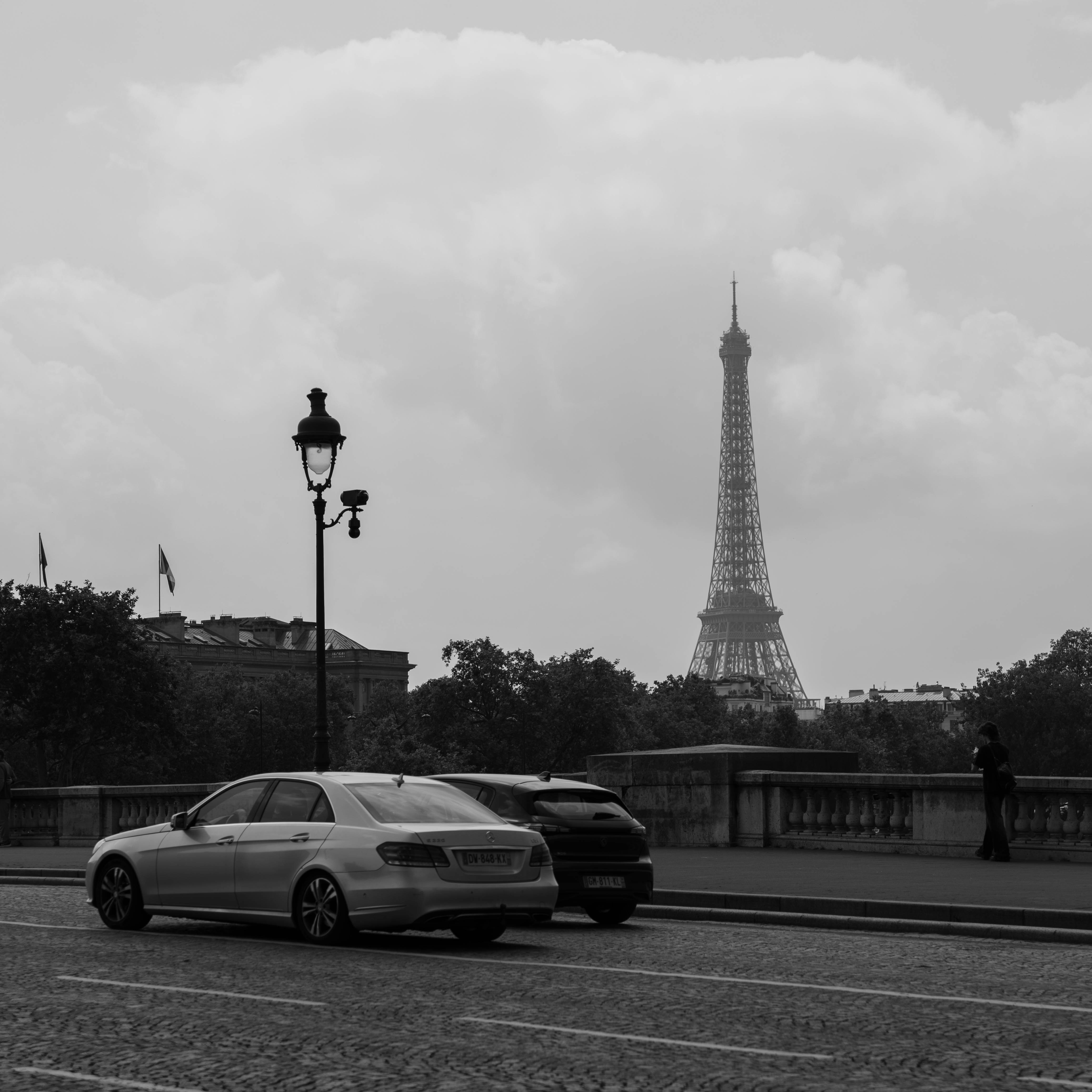 Bridgeside Silence: Eiffel Tower Rising Over a Paris Street