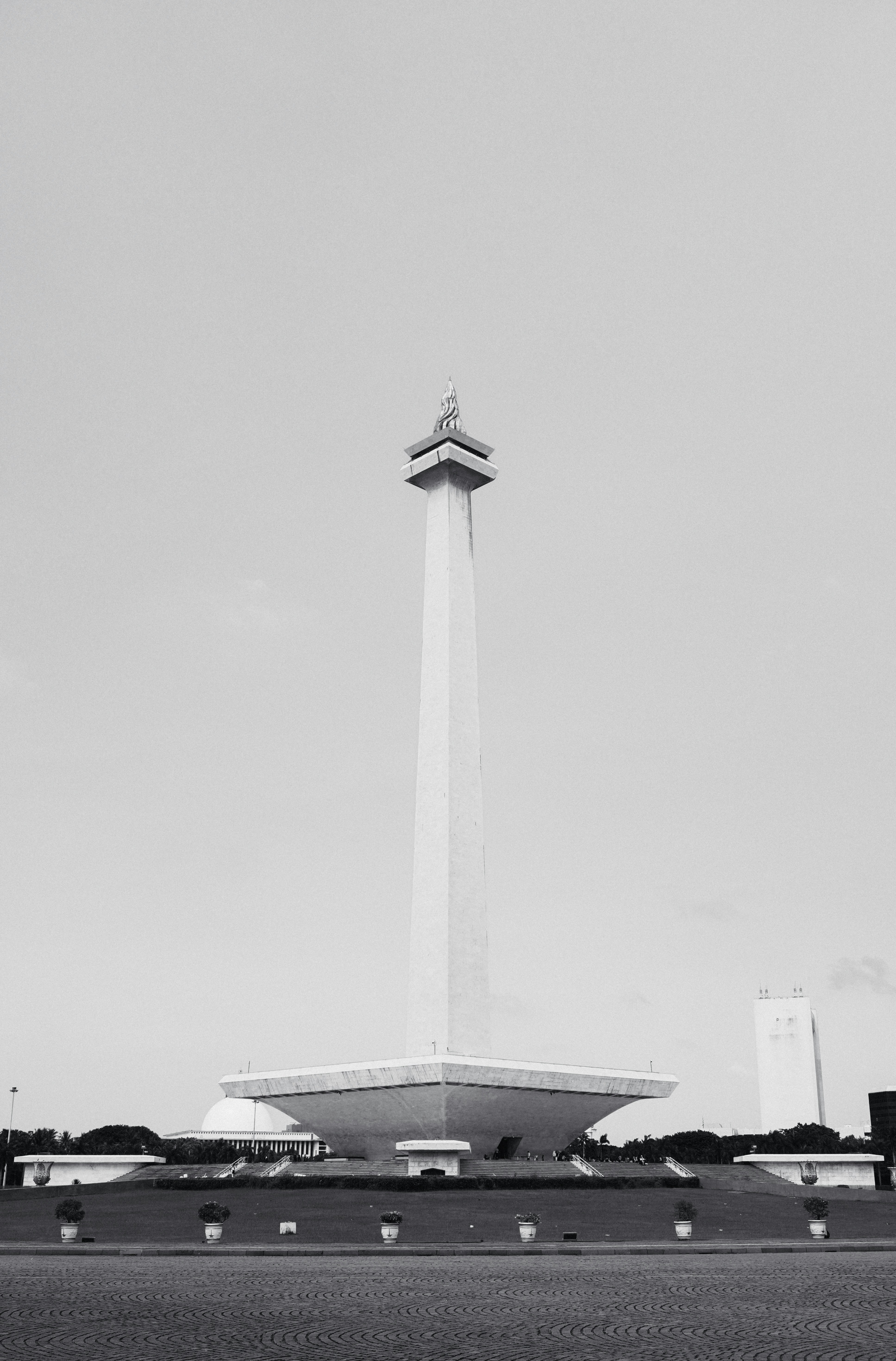 A towering monument stands proudly against a pale sky, symbolizing national pride and history. The structure's sleek lines and modern design invite contemplation.