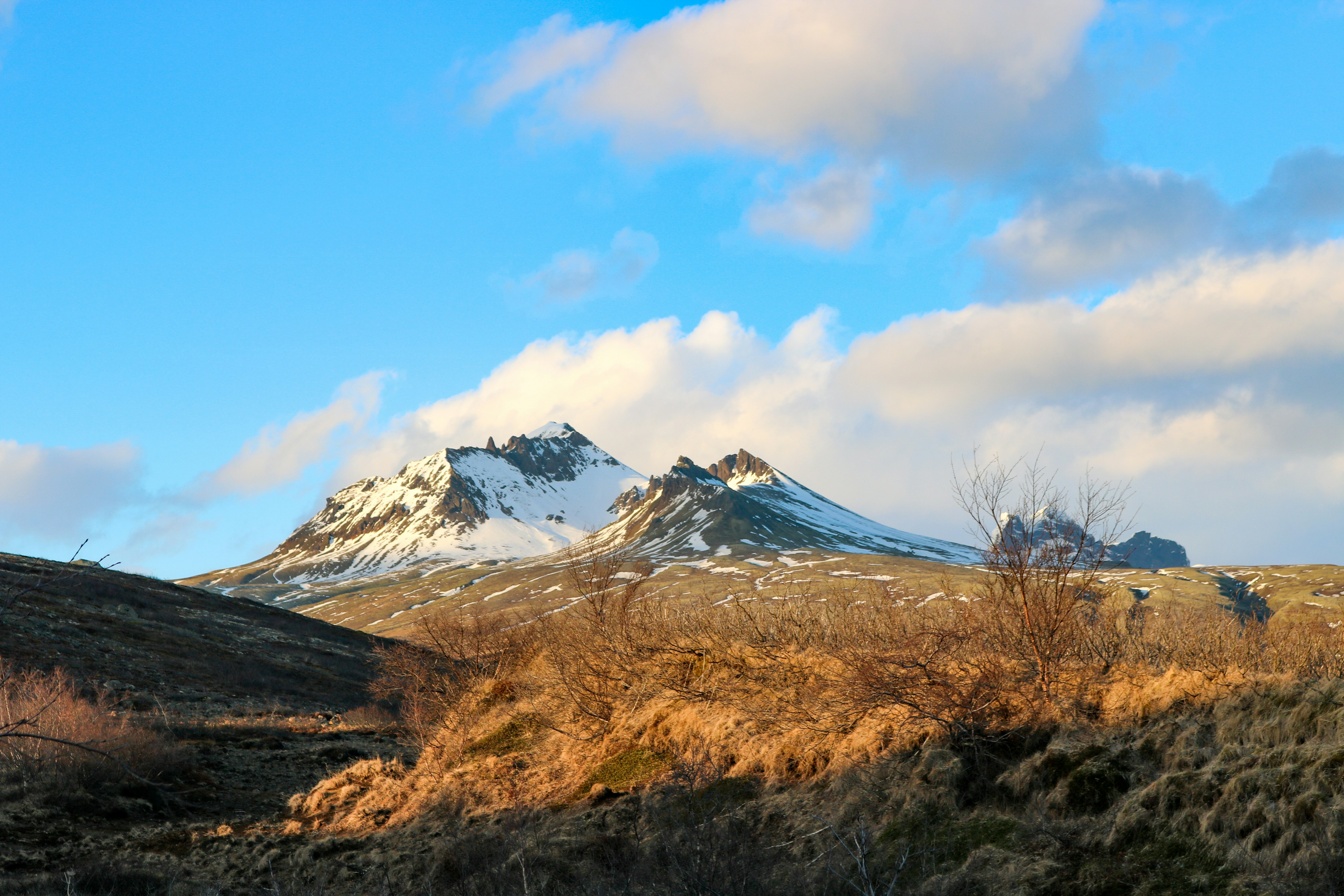 Snowy mountains and fluffy clouds fill the landscape. photo – Free ...