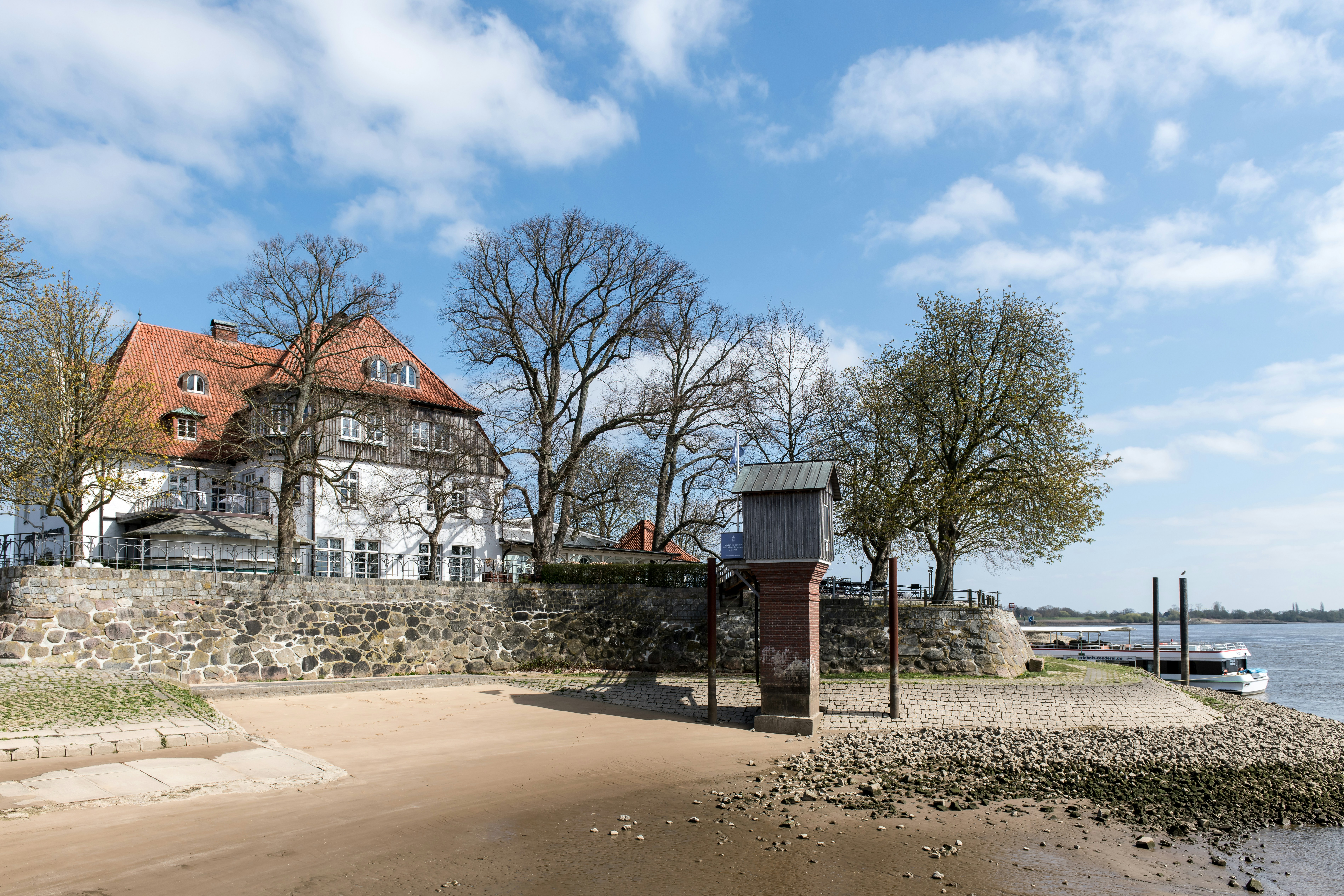 Harbor House at Low Tide: Stone Wall and Leafless Trees