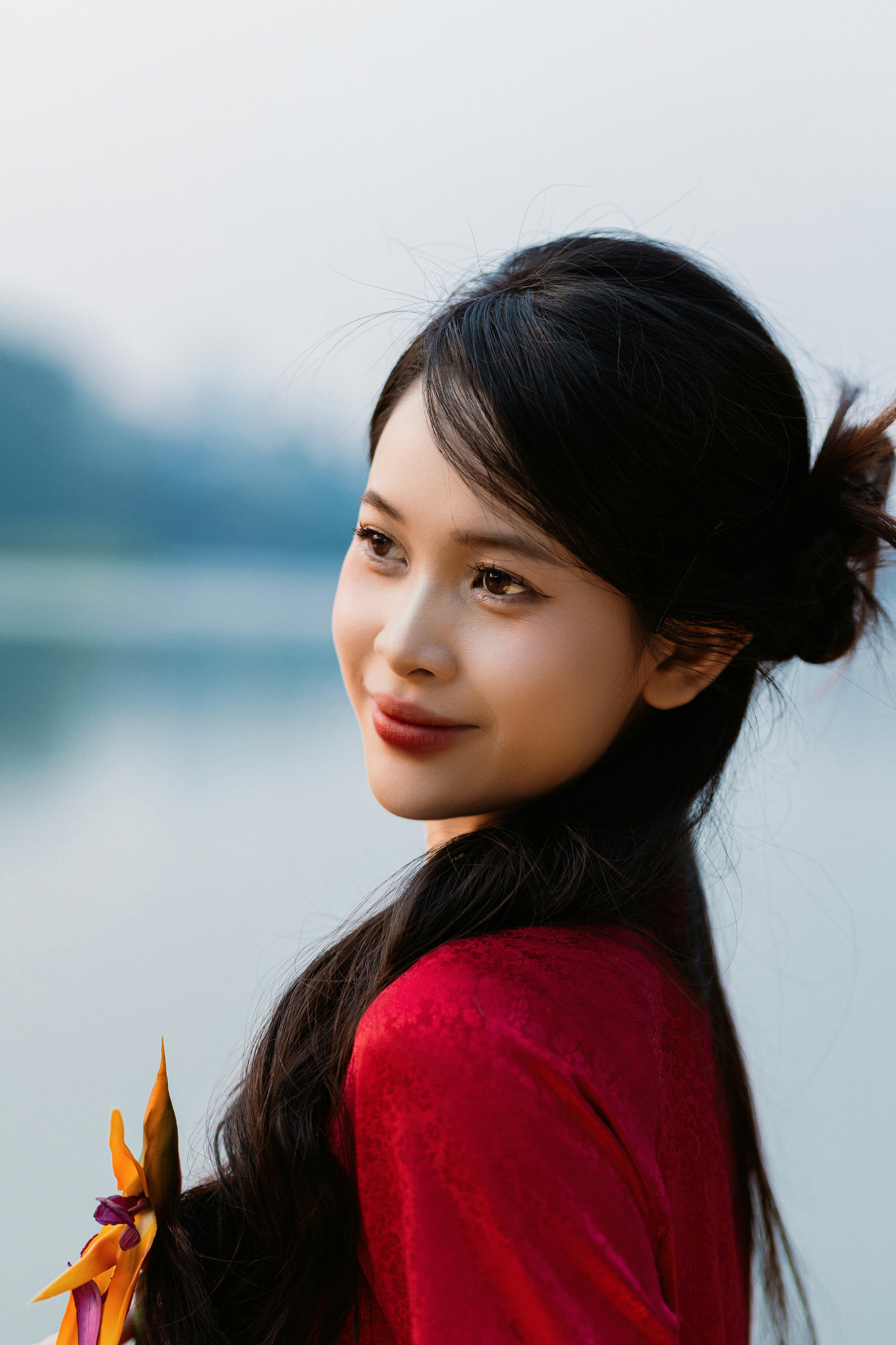 Crimson Quietude by the Lakeside: A Portrait with Soft Bokeh