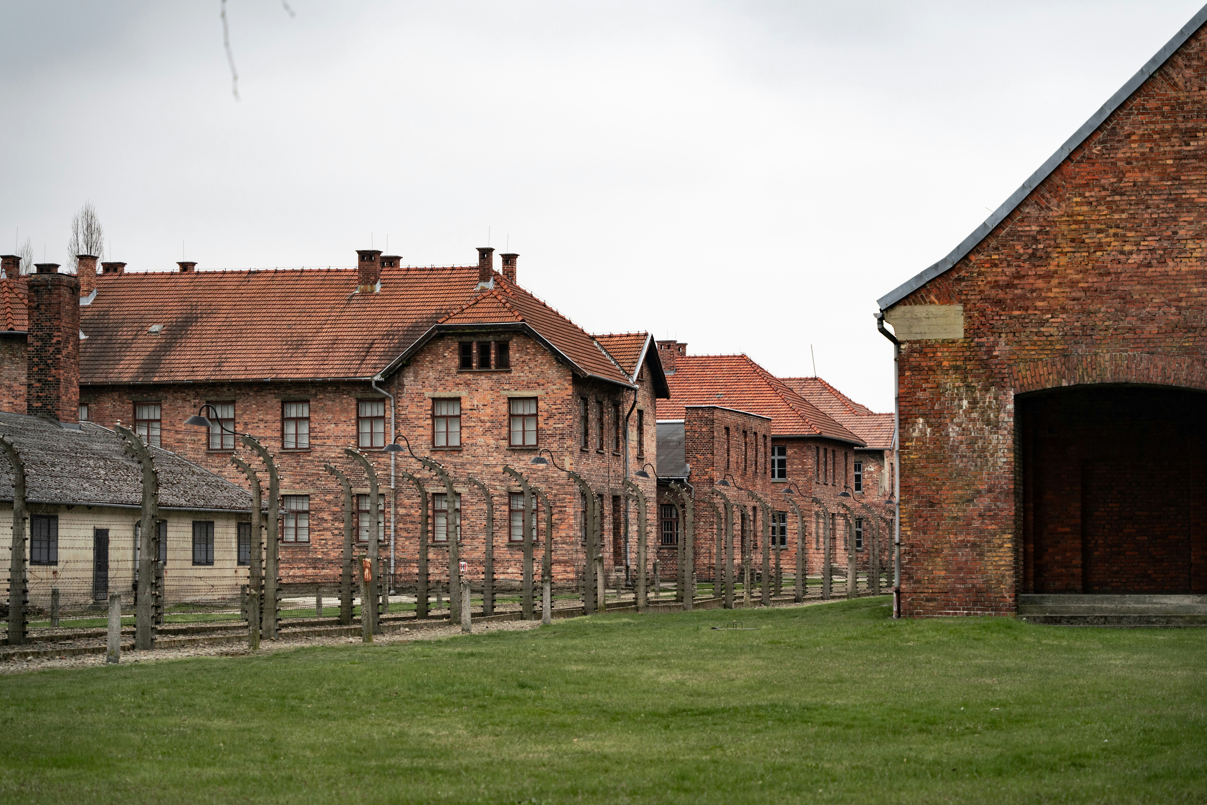 Auschwitz concentration camp buildings with barbed wire fences. photo ...