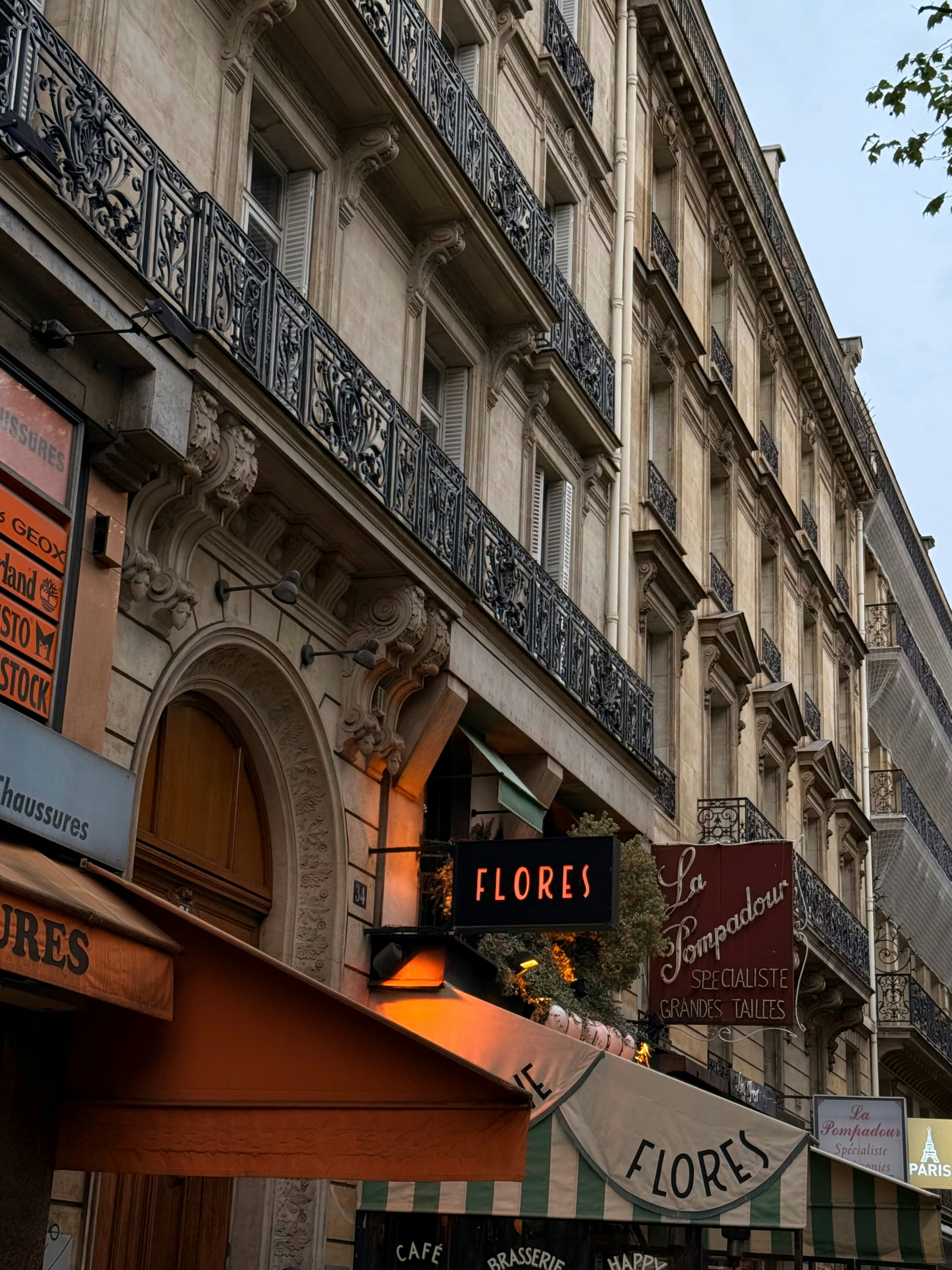 A paris street scene with shops and ornate buildings. photo – Free ...