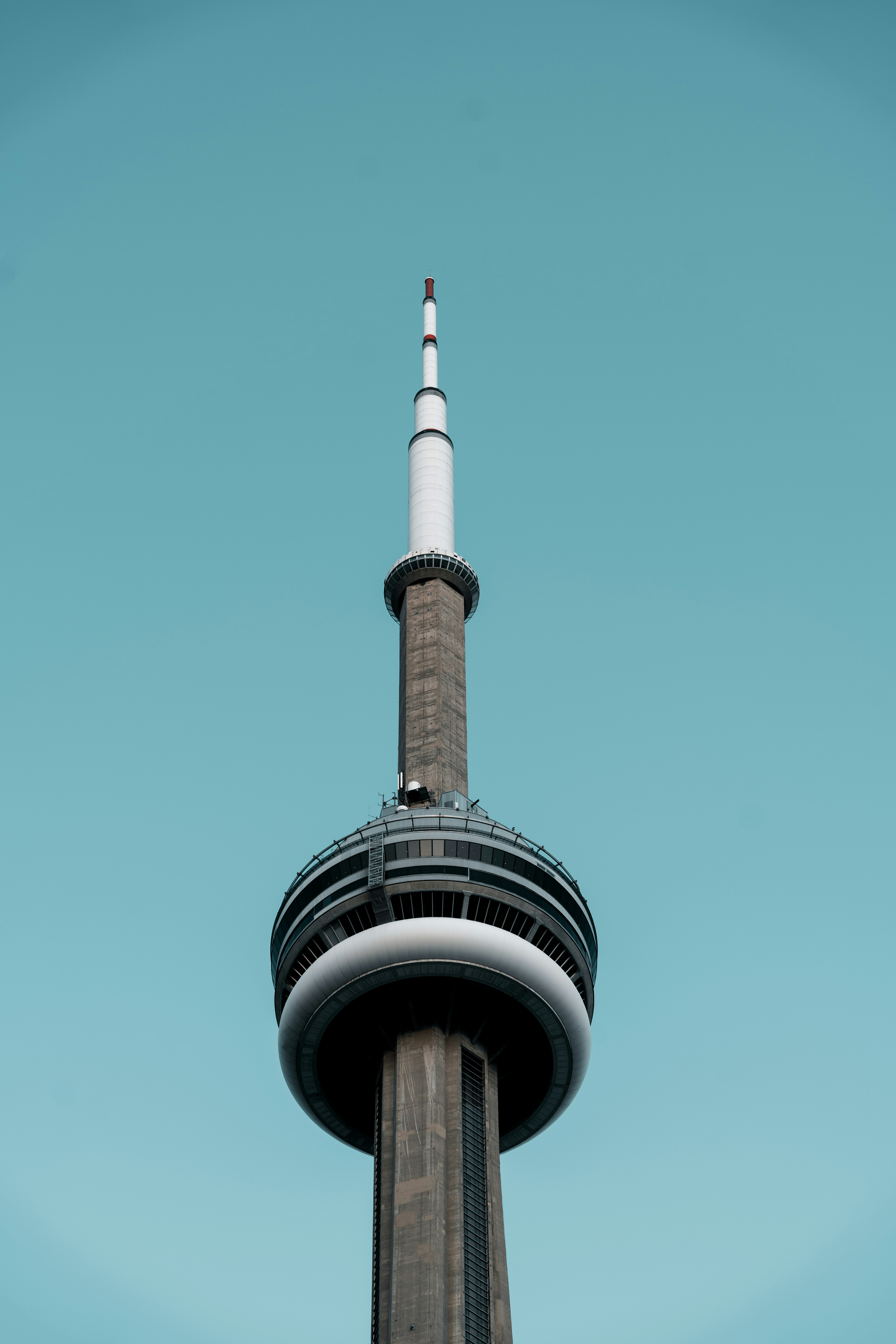 The cn tower stands tall against the blue sky. photo – Free Building ...