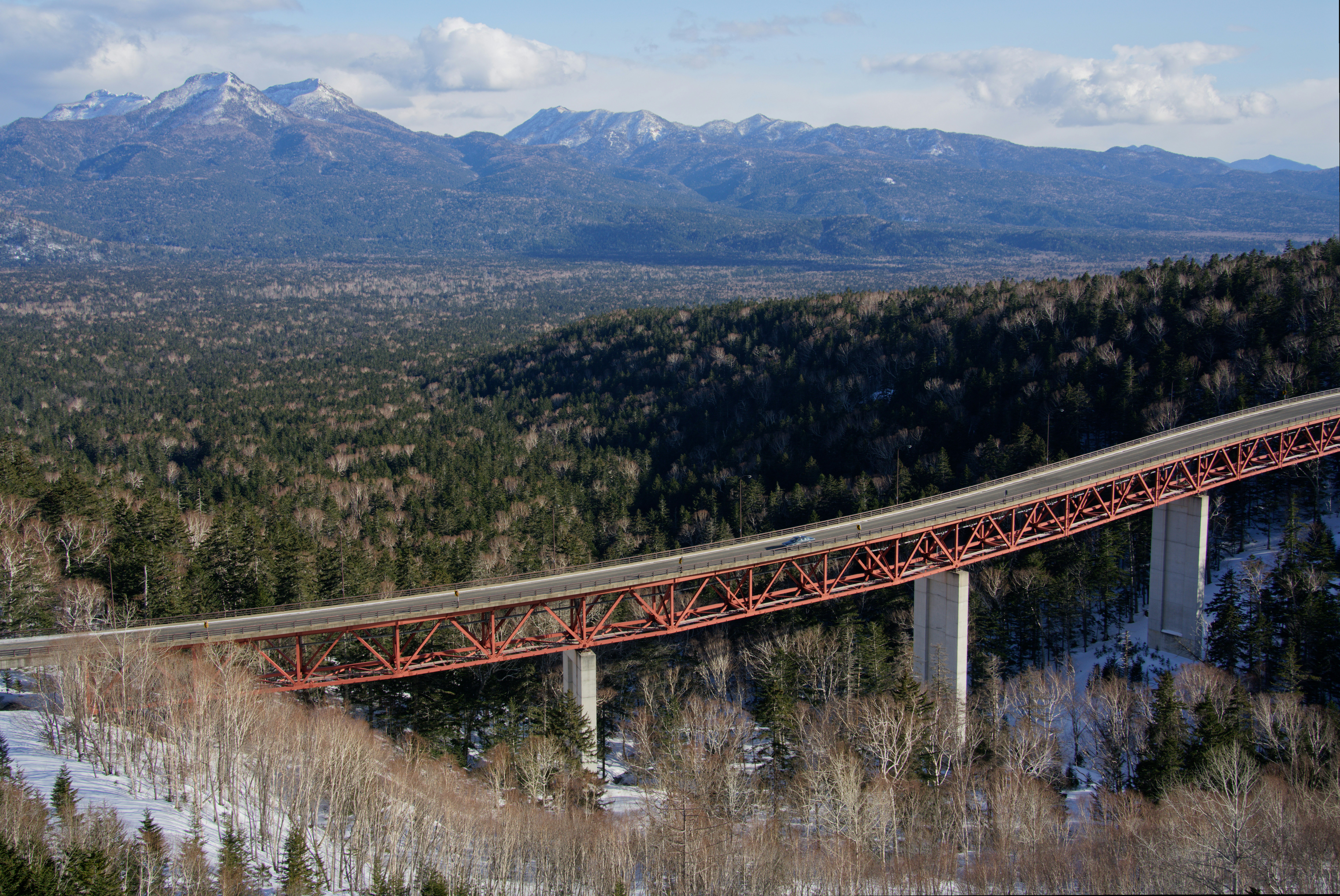 Arc of Steel: A Snow-Kissed Valley Bridge