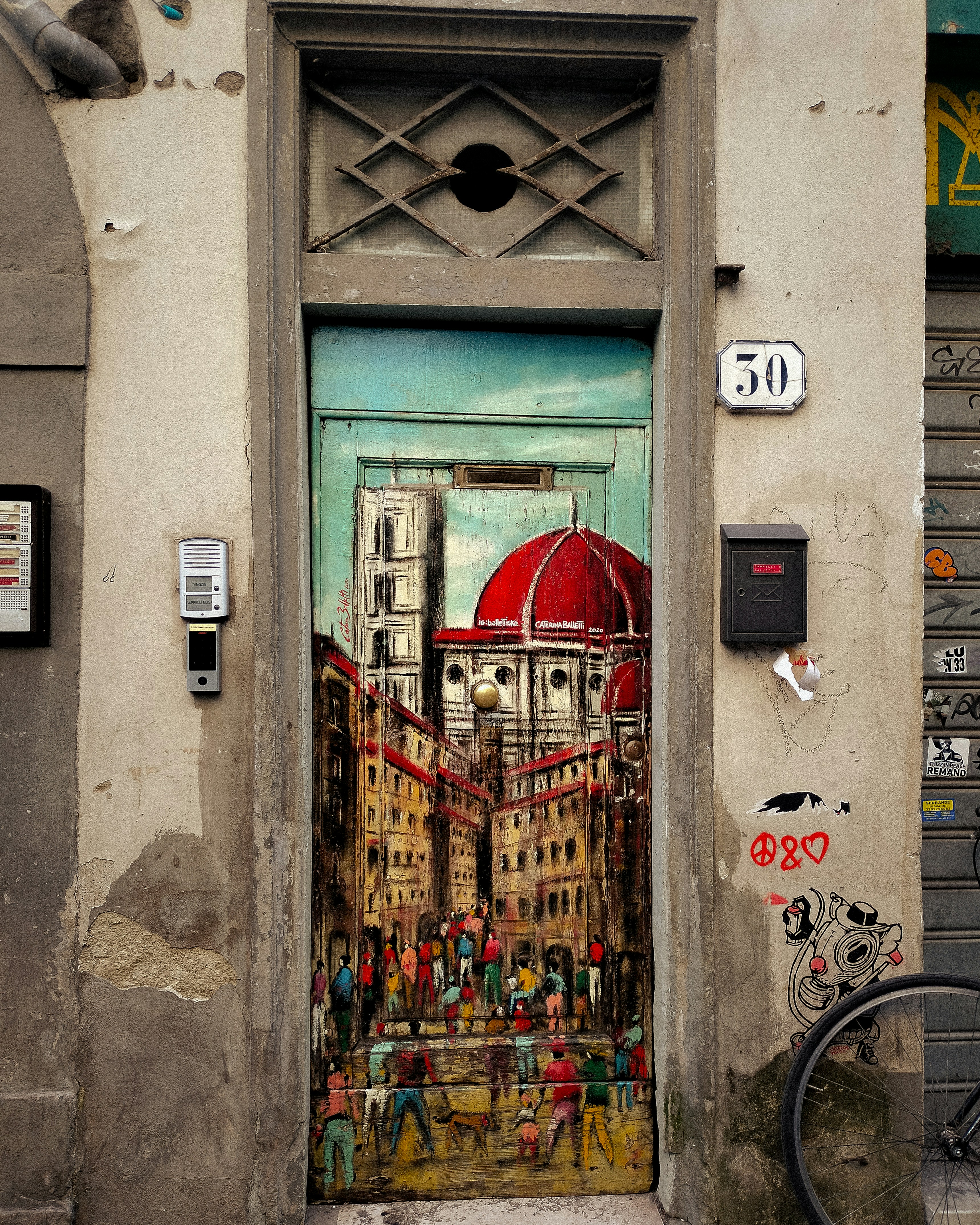 A doorway mural depicts a bustling city street beneath a red-domed cathedral, framed by weathered walls.