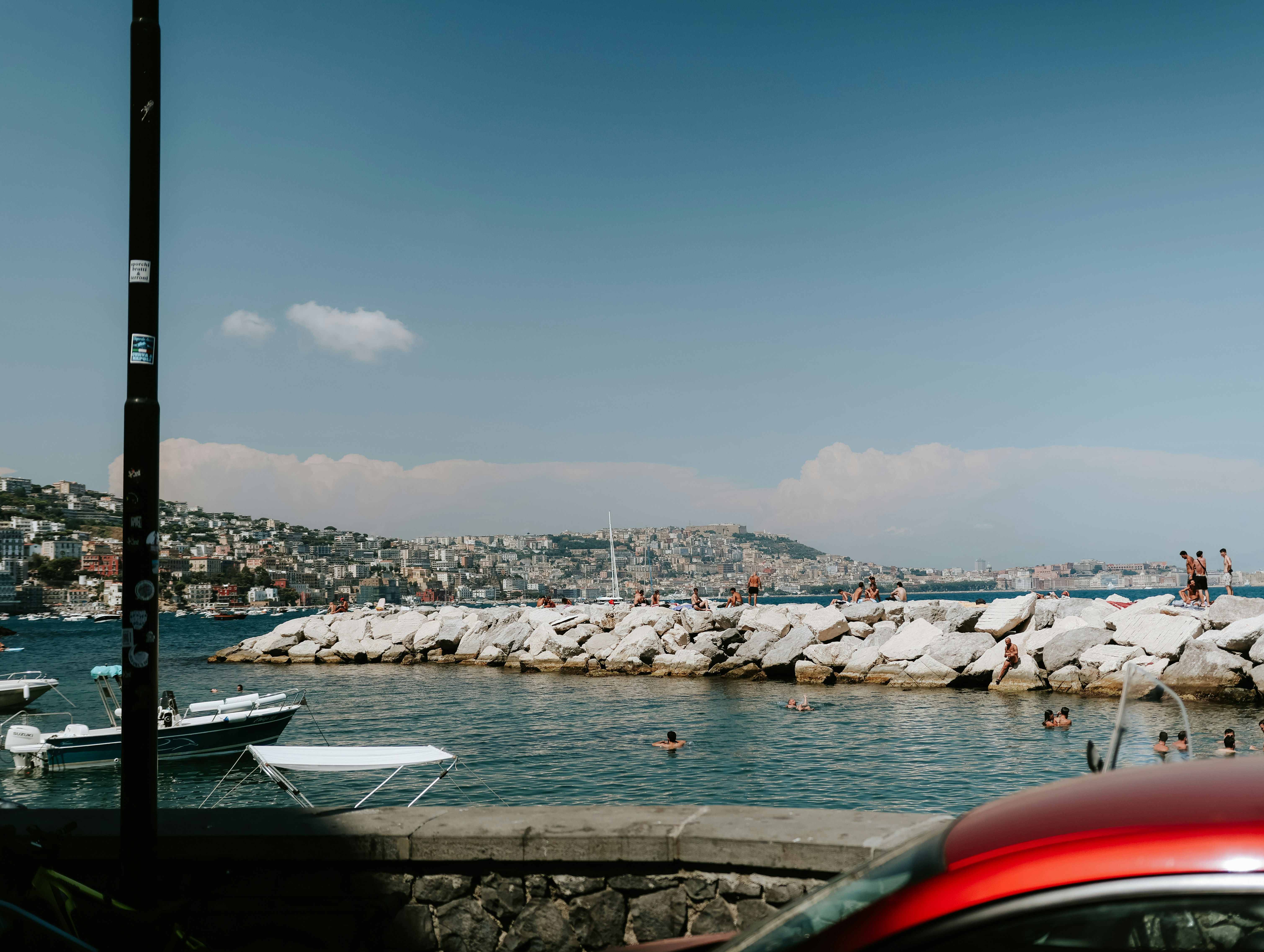 Crimson Foreground at the Quay: A Quiet Harbor Under a Wide Blue Sky