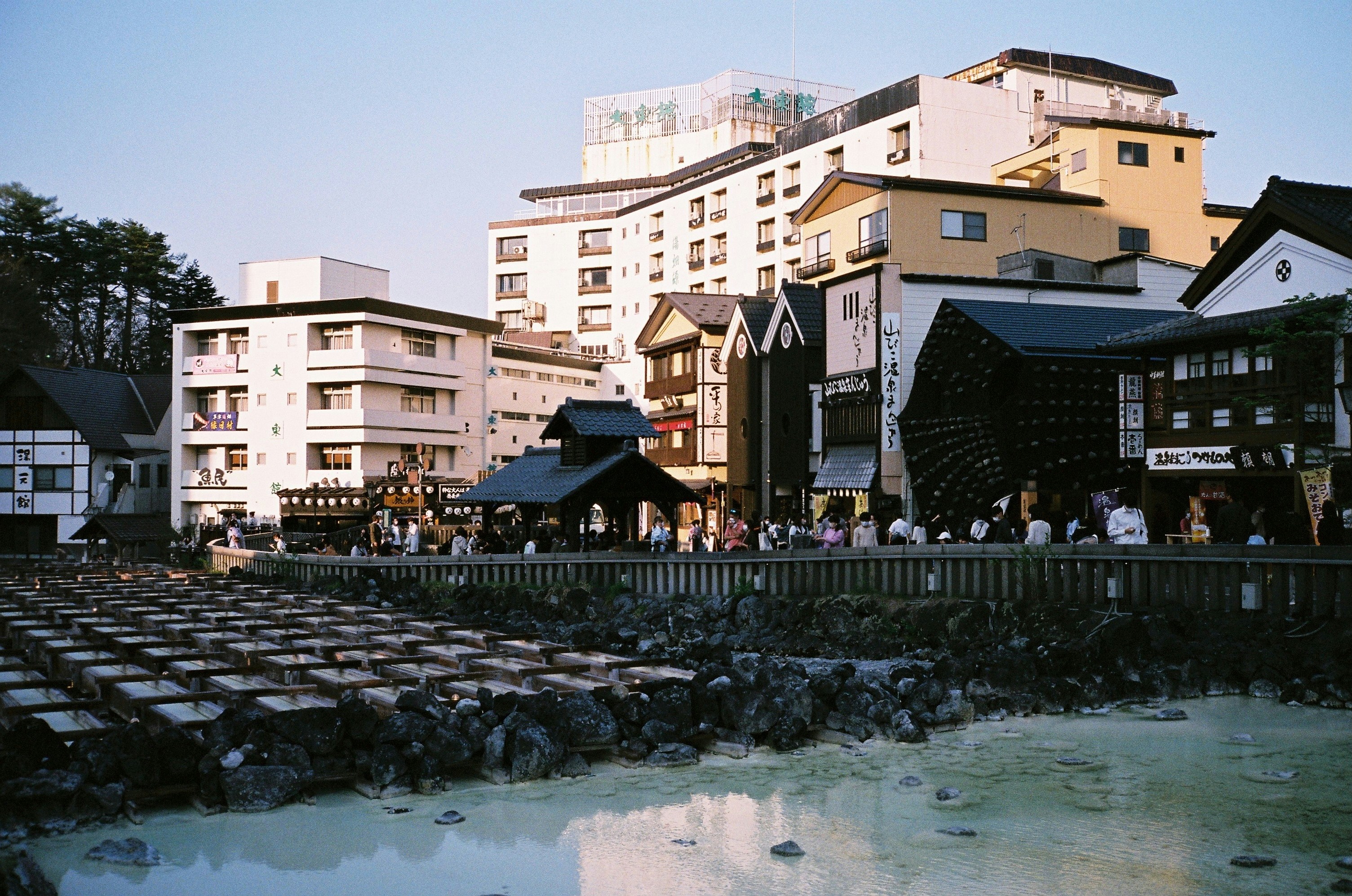 Historic buildings juxtaposed with modern architecture in a bustling Japanese town, showcasing local culture and lifestyle.